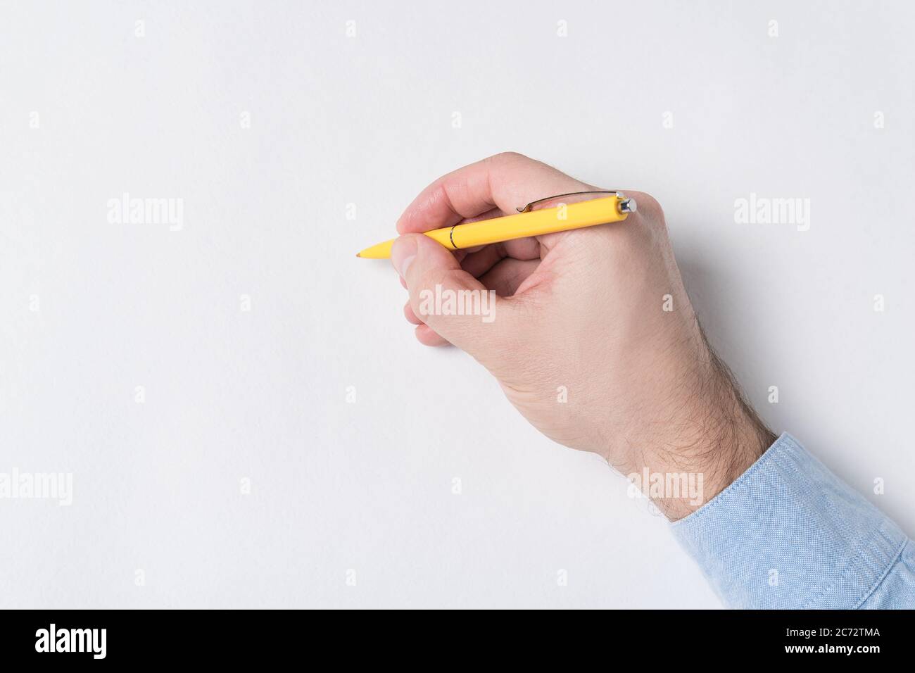 Male hand with pen, white background. Man puts signature. Close up ...