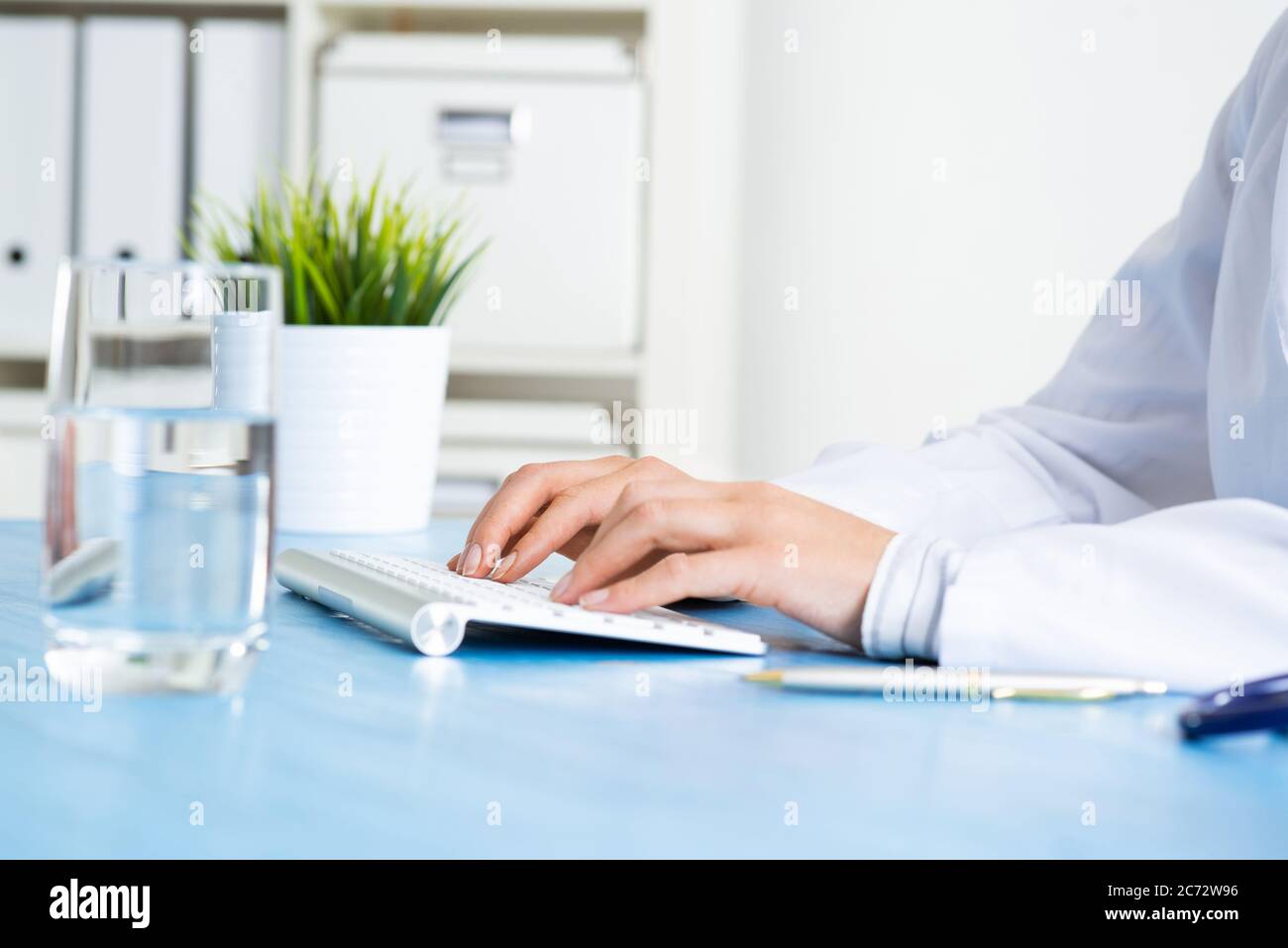 Doctor typing at computer keyboard Stock Photo - Alamy