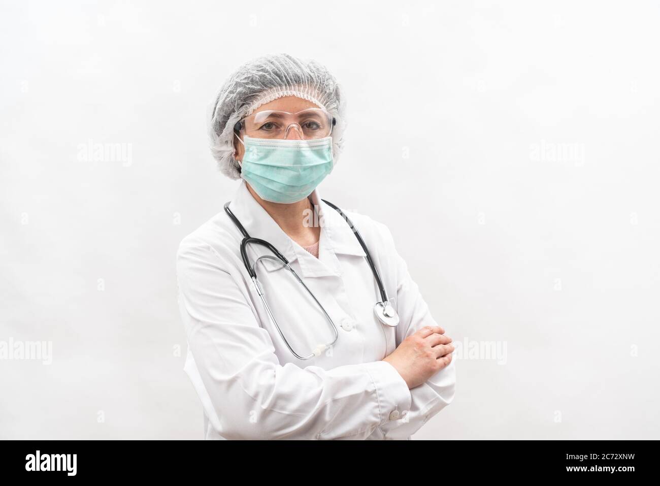 Tired female medic, nurse in protective equipment and a mask from ...