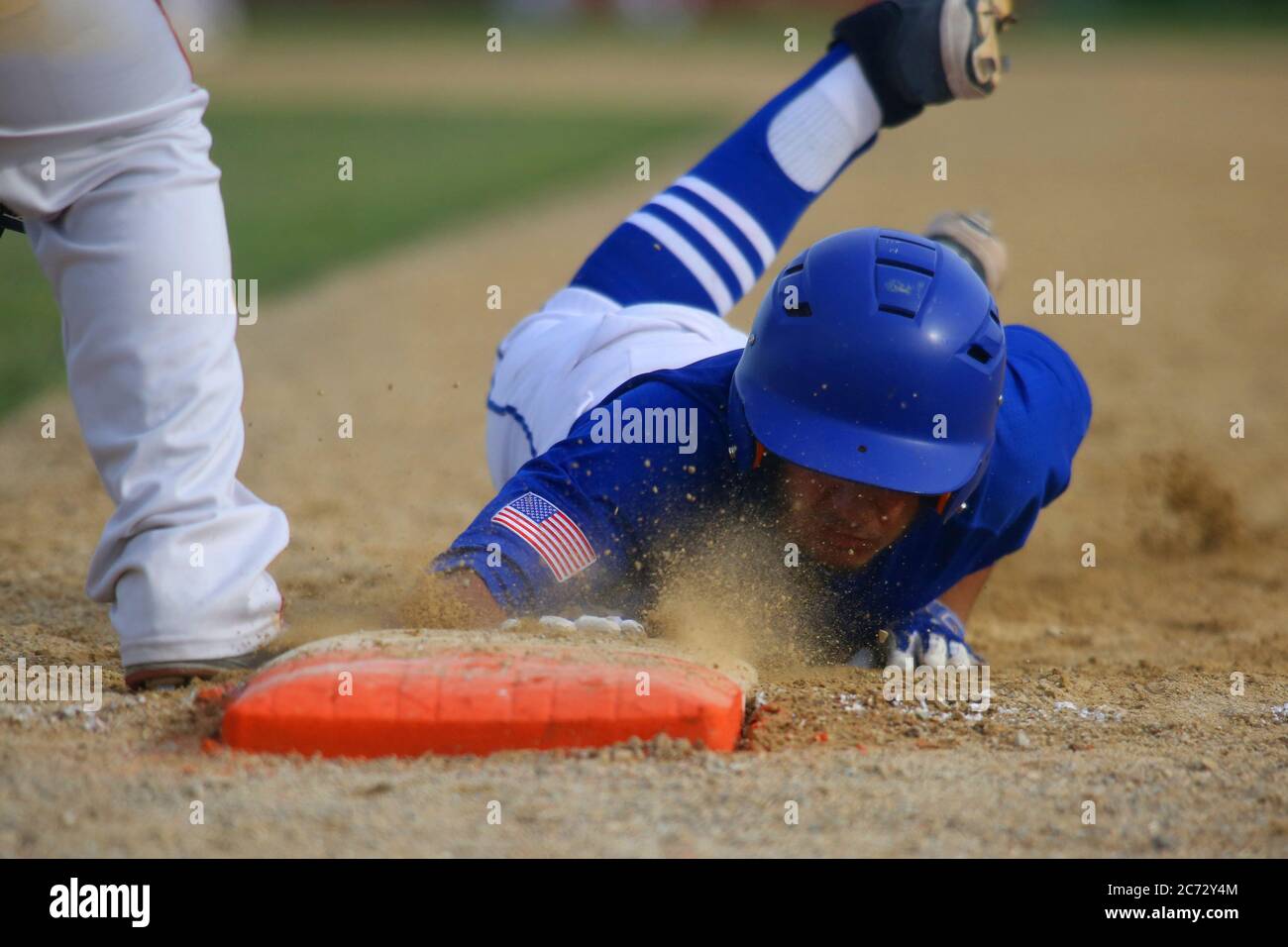 A baserunner scrambles back to first on an attempted pick-off in a ...