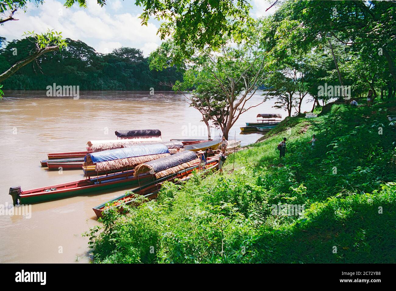 Wooden boats docked at the pathway up to the Yaxchilan Mayan Ruins ...