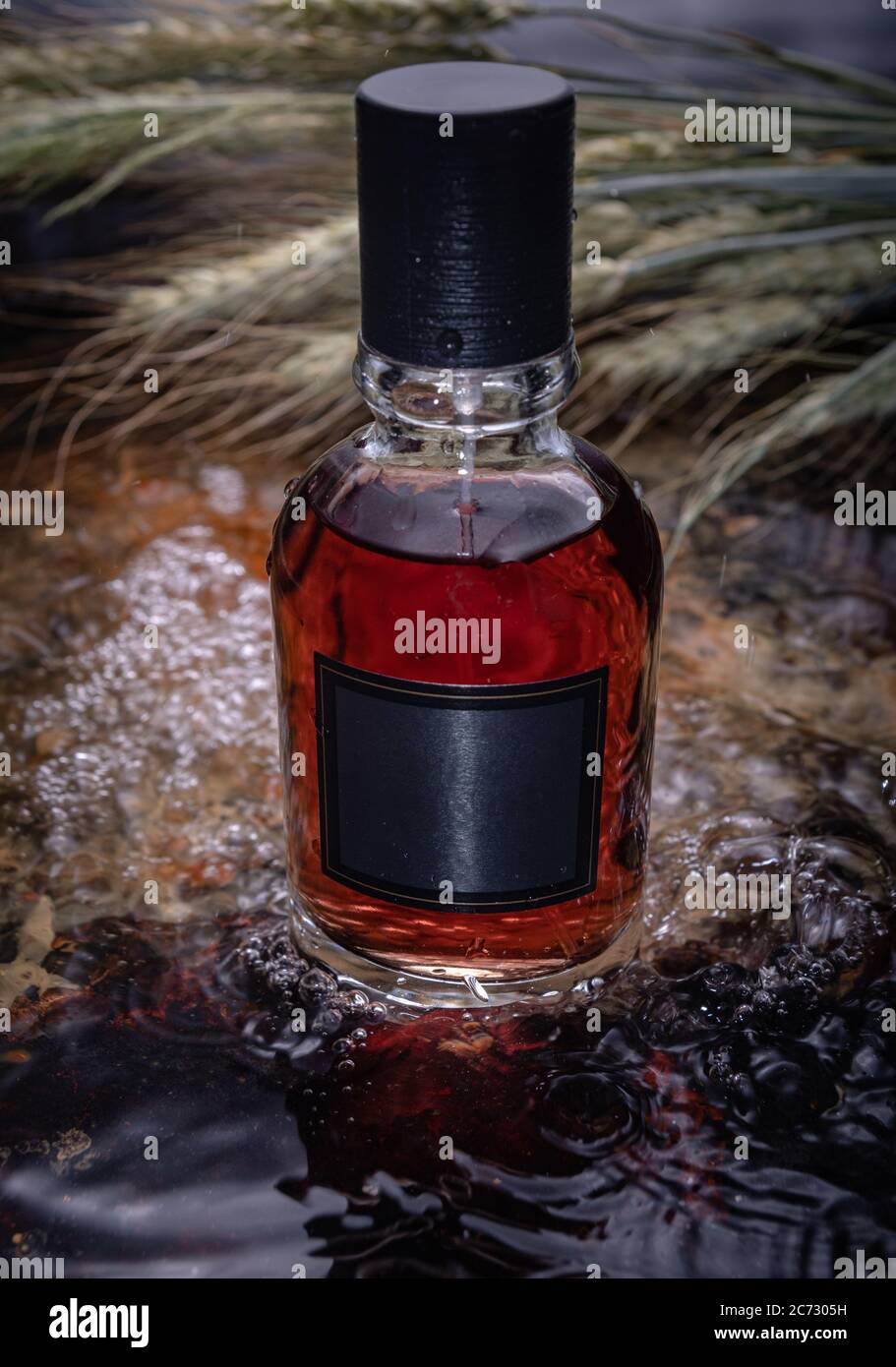 Perfume pink in water with spray. Perfume bottle. Vertical frame Stock ...