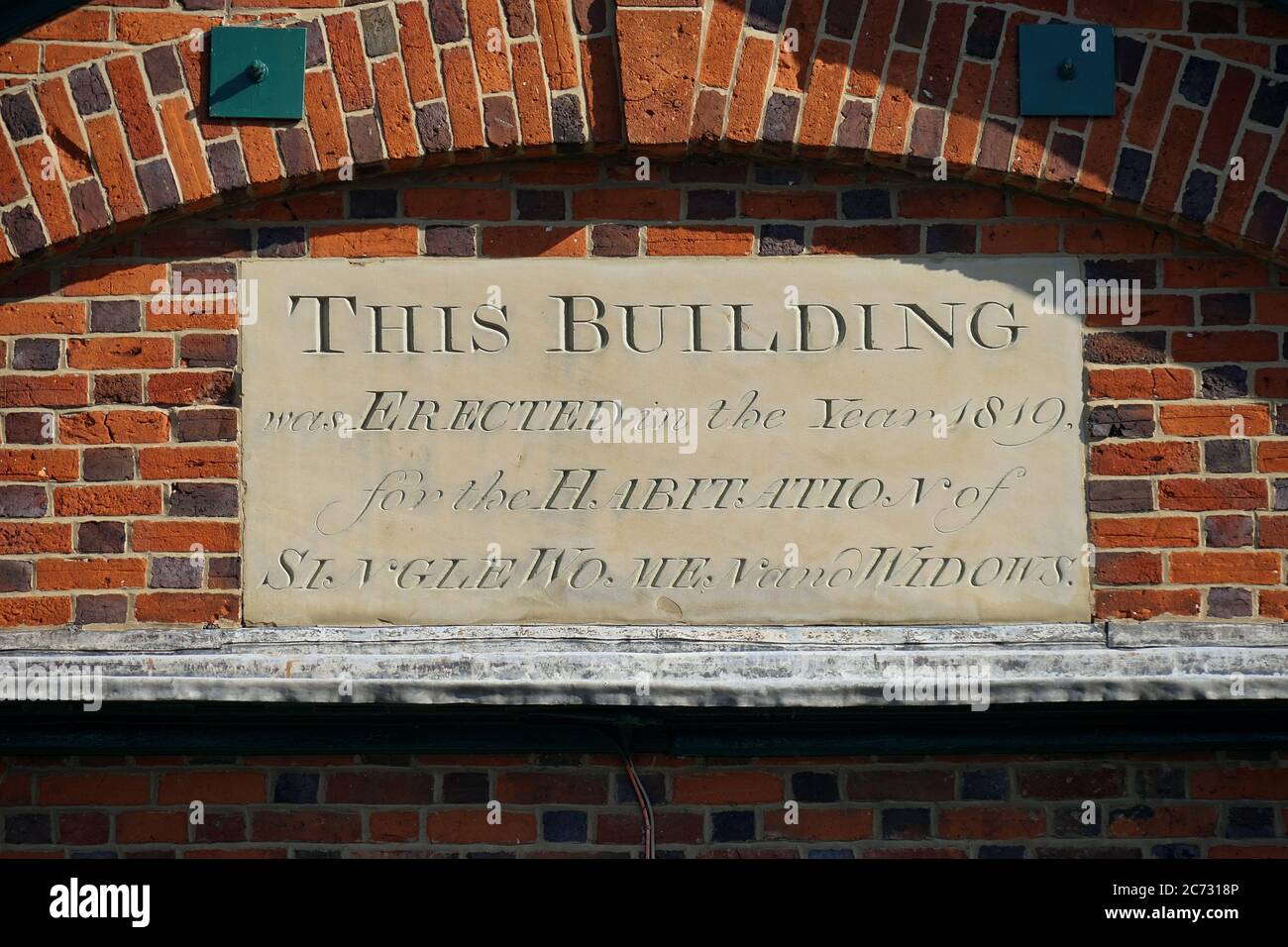 Plaque on the old Georgian almhouses at Olney Stock Photo - Alamy