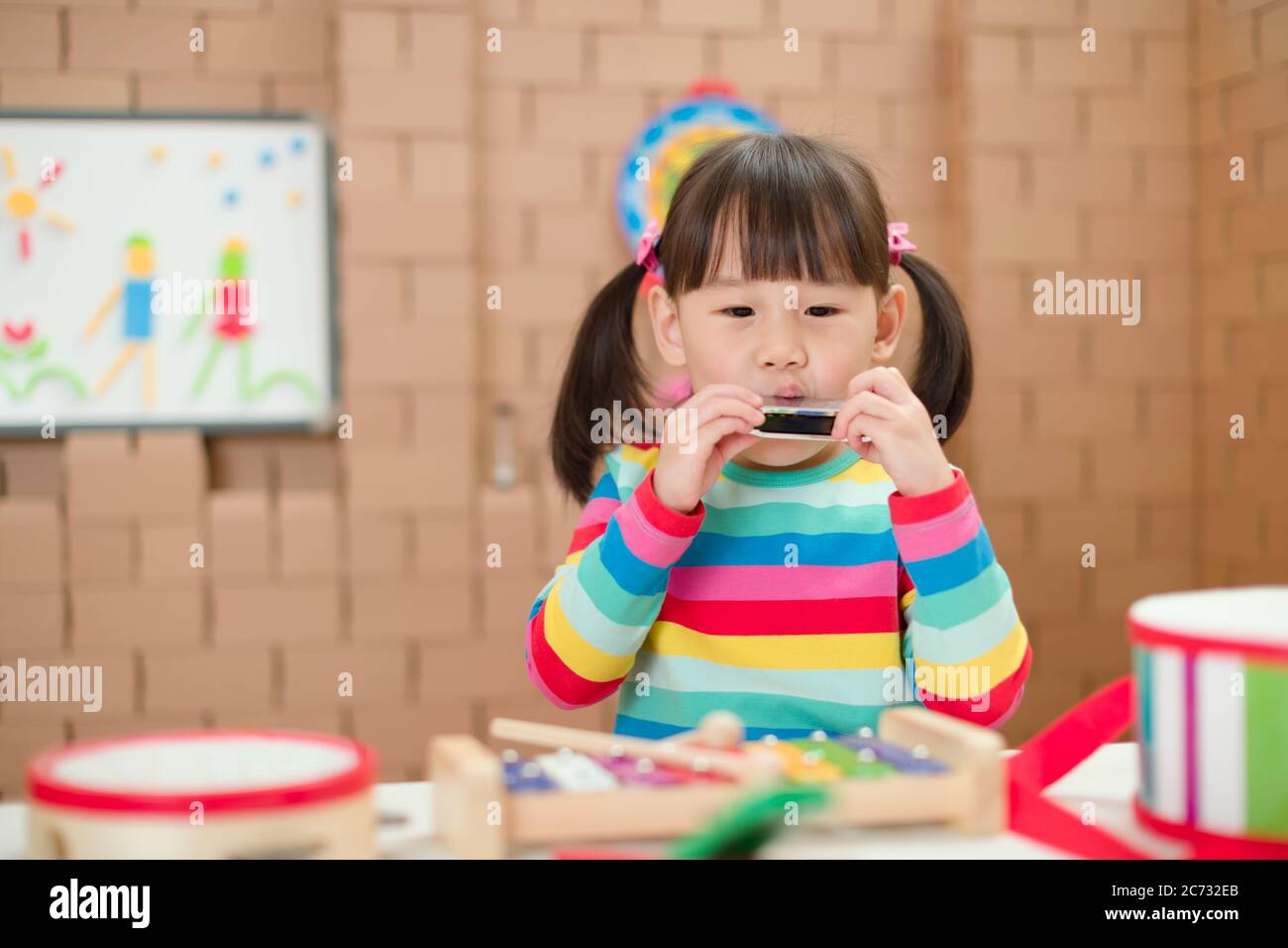 Chinese kids playing musical instrument hi-res stock photography and ...