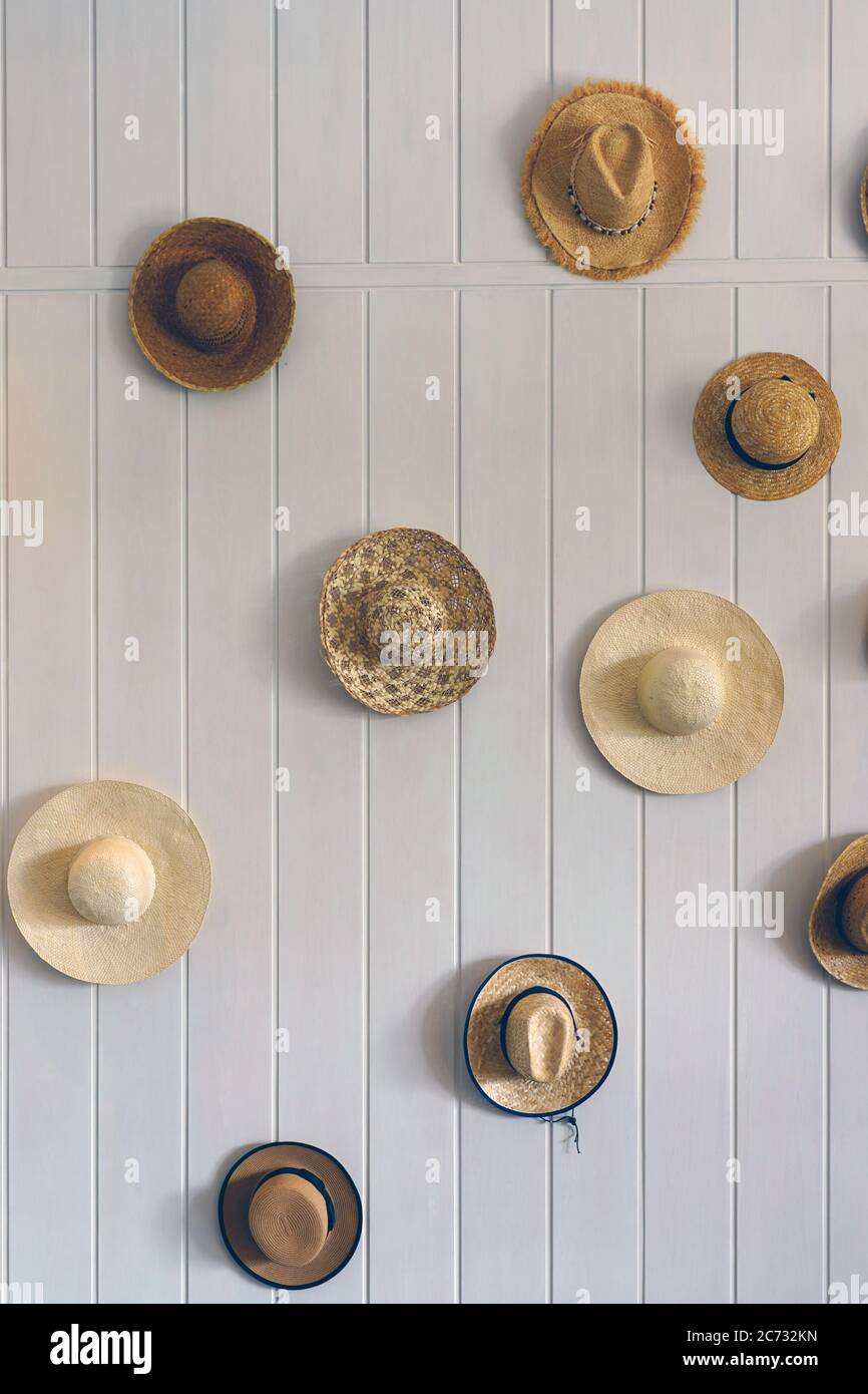 Display of summer straw hats on a white wall Stock Photo - Alamy
