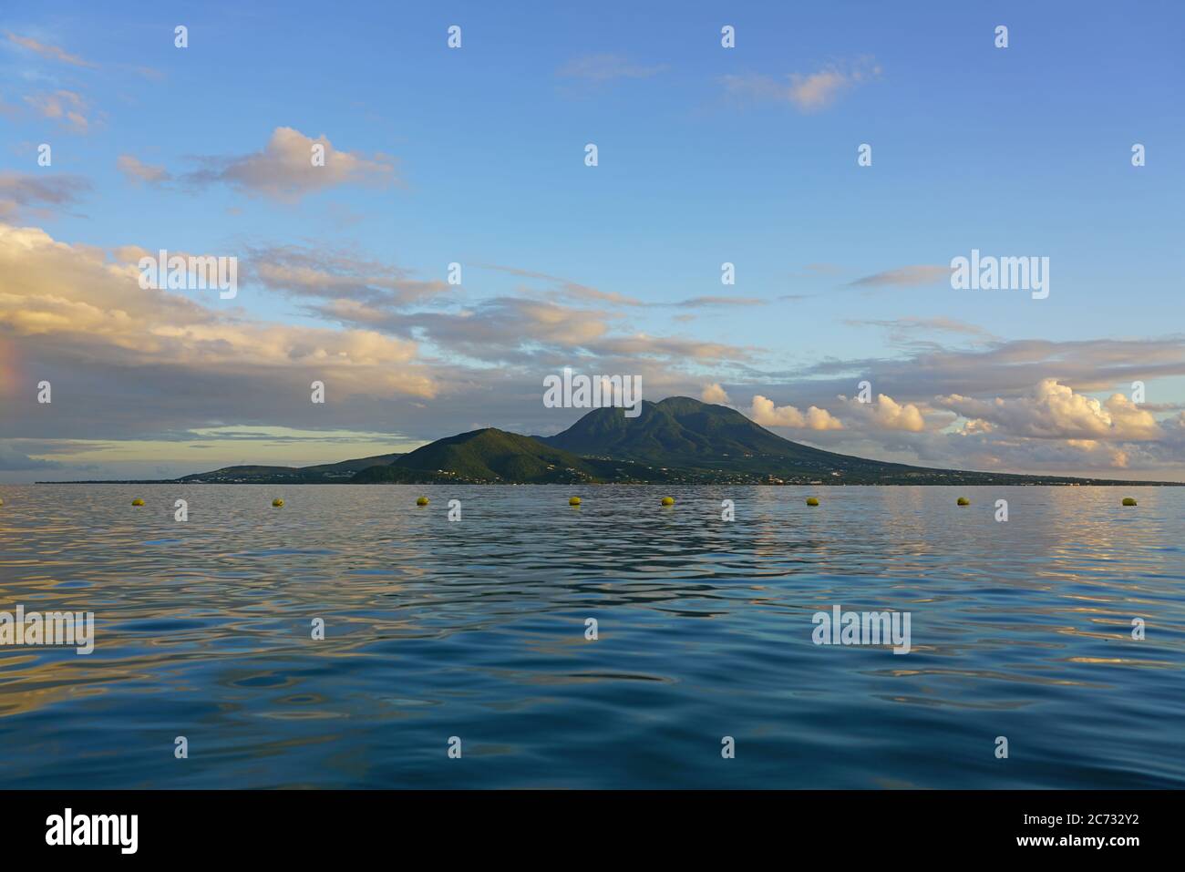 Sunset view of the Nevis Peak volcano across the water from St Kitts ...
