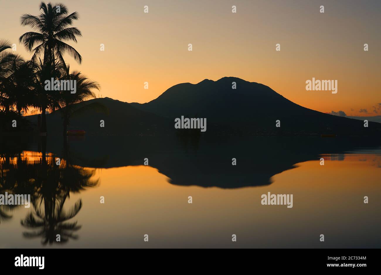 Sunset view of the Nevis Peak volcano across the water from St Kitts ...