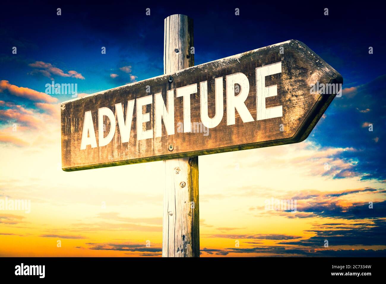 Adventure - wooden signpost, roadsign with one arrow Stock Photo - Alamy