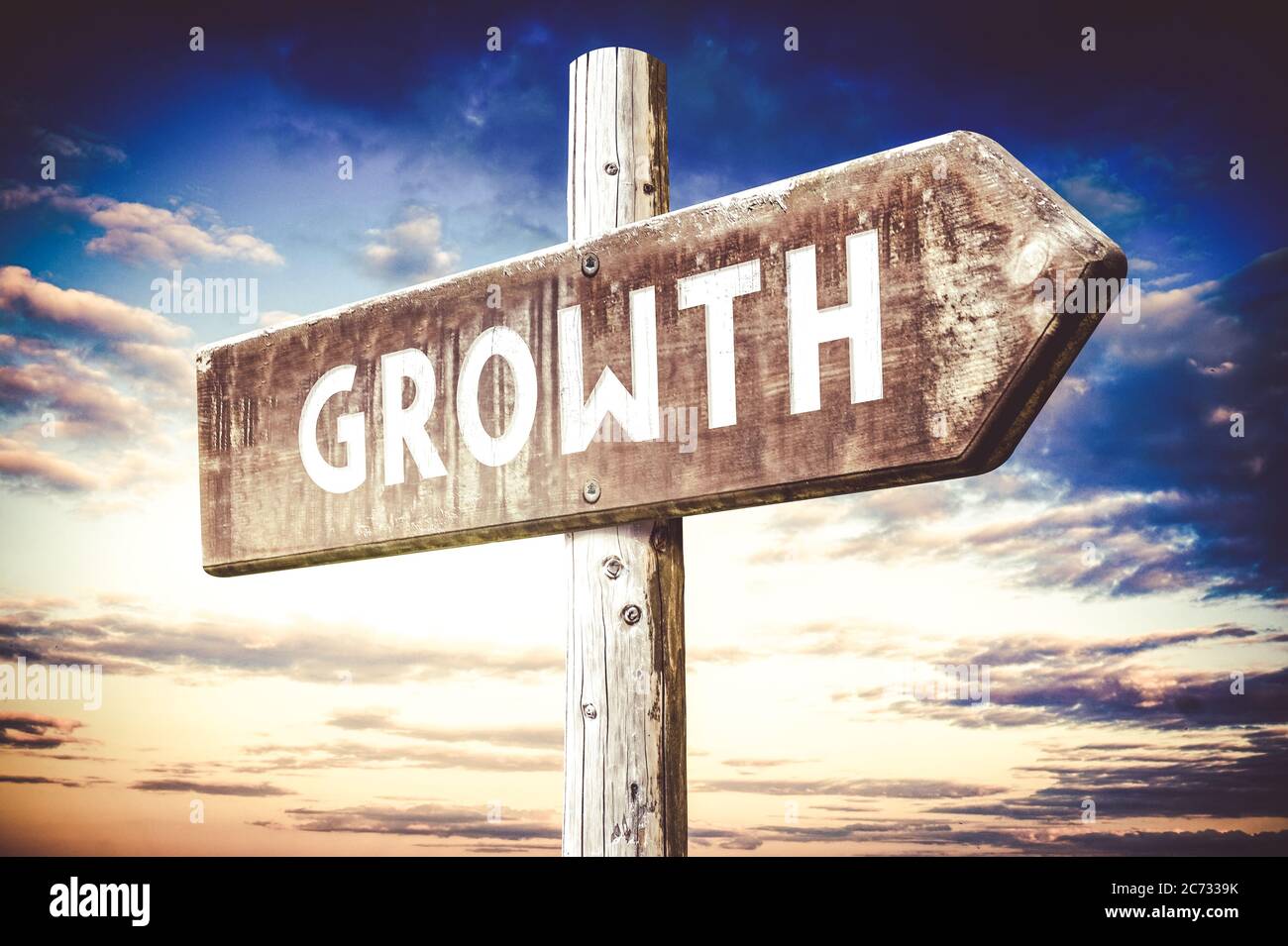 Growth - wooden signpost, roadsign with one arrow Stock Photo - Alamy