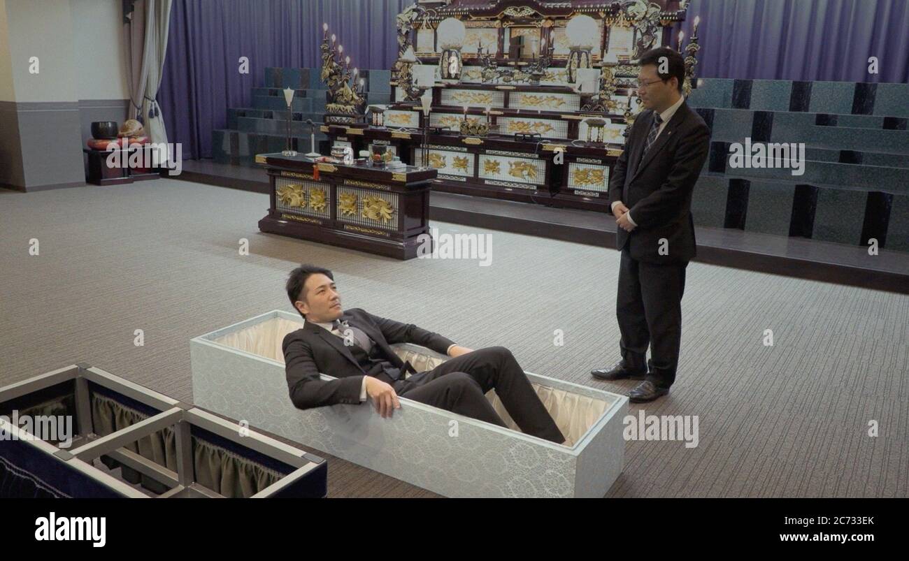 FAMILY ROMANCE, LLC, trying out the coffin: Ishii Yuichi, 2019. © MUBI ...