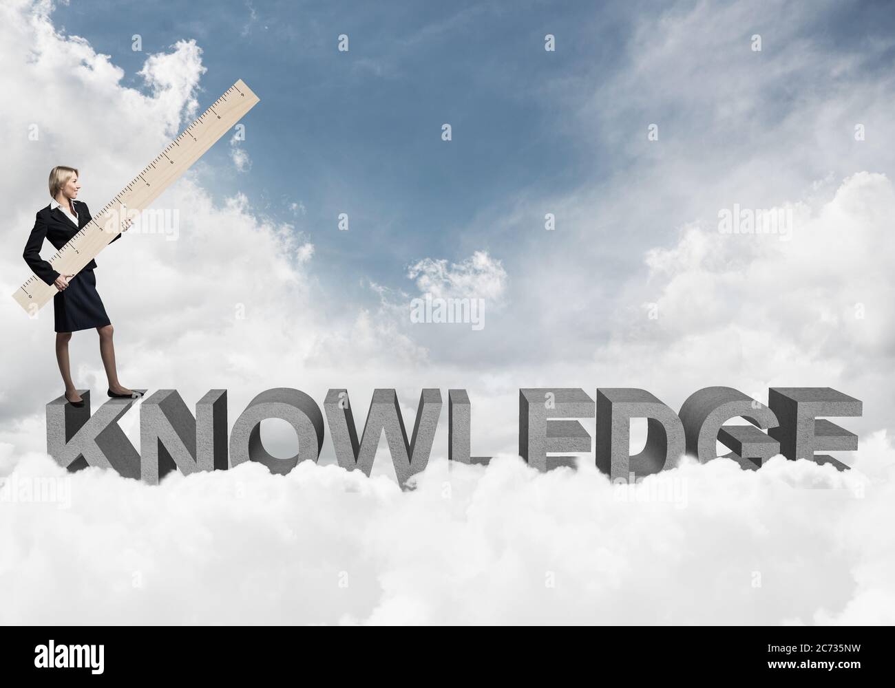 Young teacher holding big ruler Stock Photo - Alamy