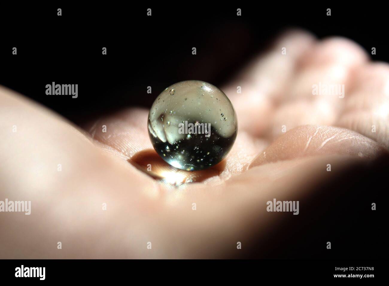 Marble in the hand Stock Photo - Alamy