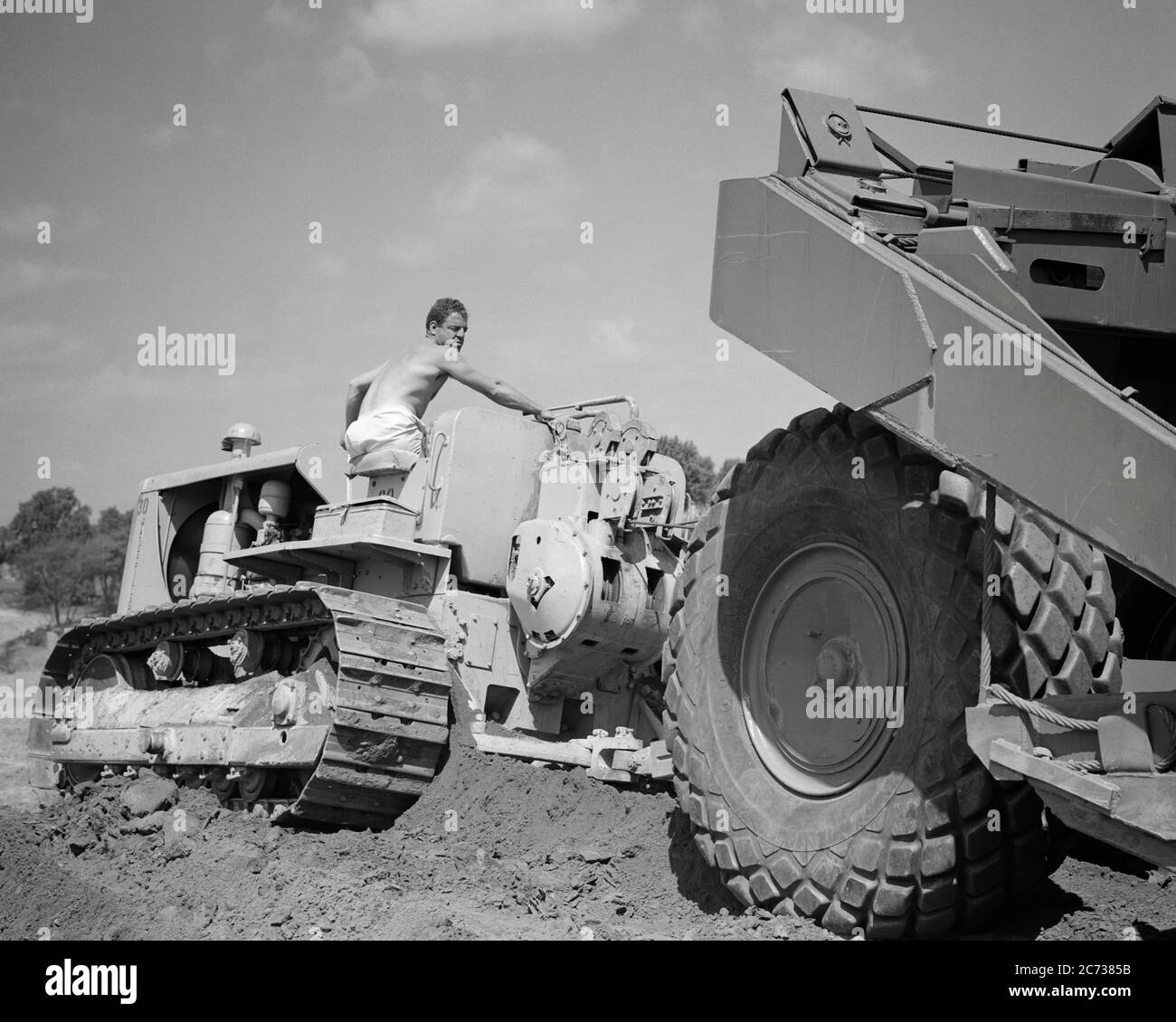 1950s SHIRTLESS MAN WORKER RIDING ON DRIVING BULLDOZER OPERATING HEAVY ...