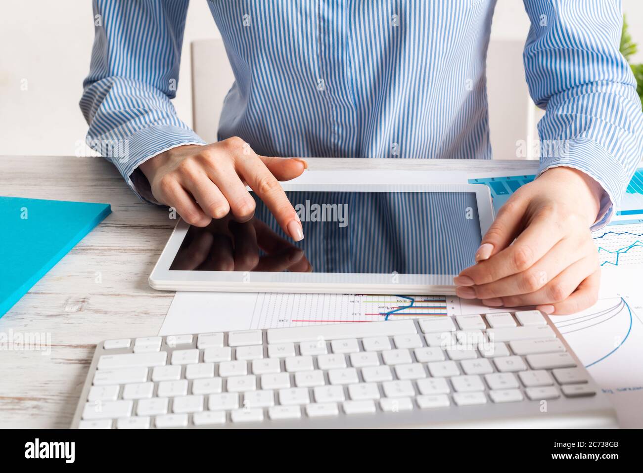 Manager using tablet computer with blank screen Stock Photo - Alamy