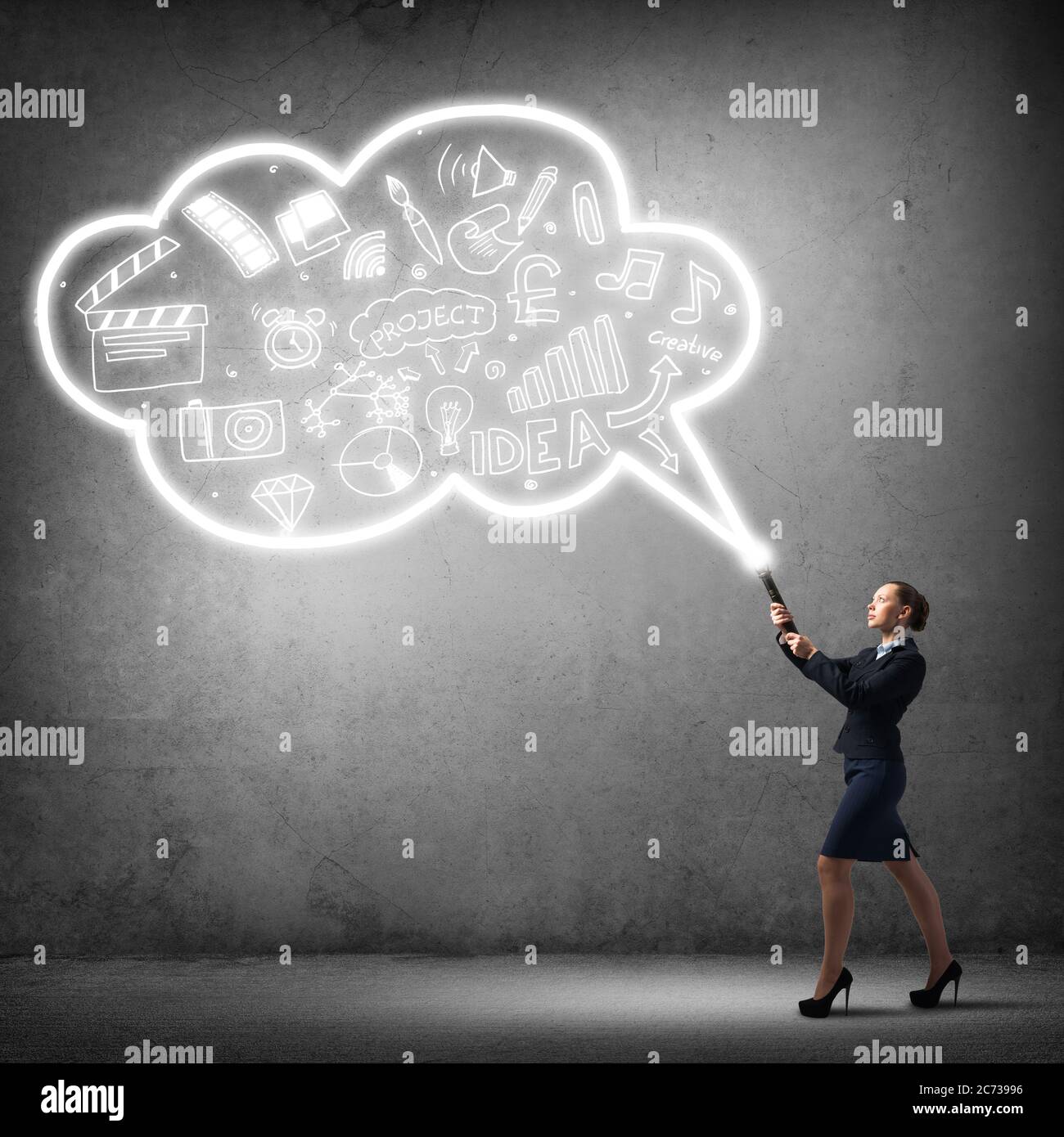Woman throwing light on her ideas Stock Photo - Alamy