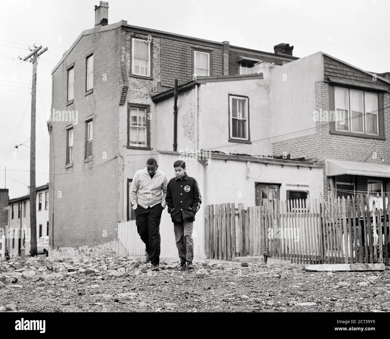 1960s TWO AT ODDS AFRICAN AMERICAN TEENAGE BOYS WALKING THROUGH ...