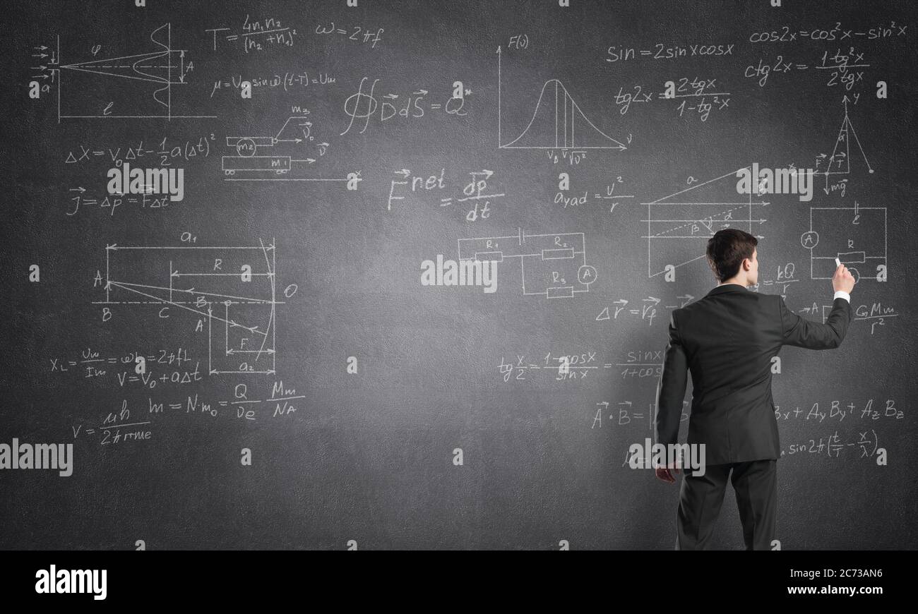 Man writing on blackboard Stock Photo - Alamy