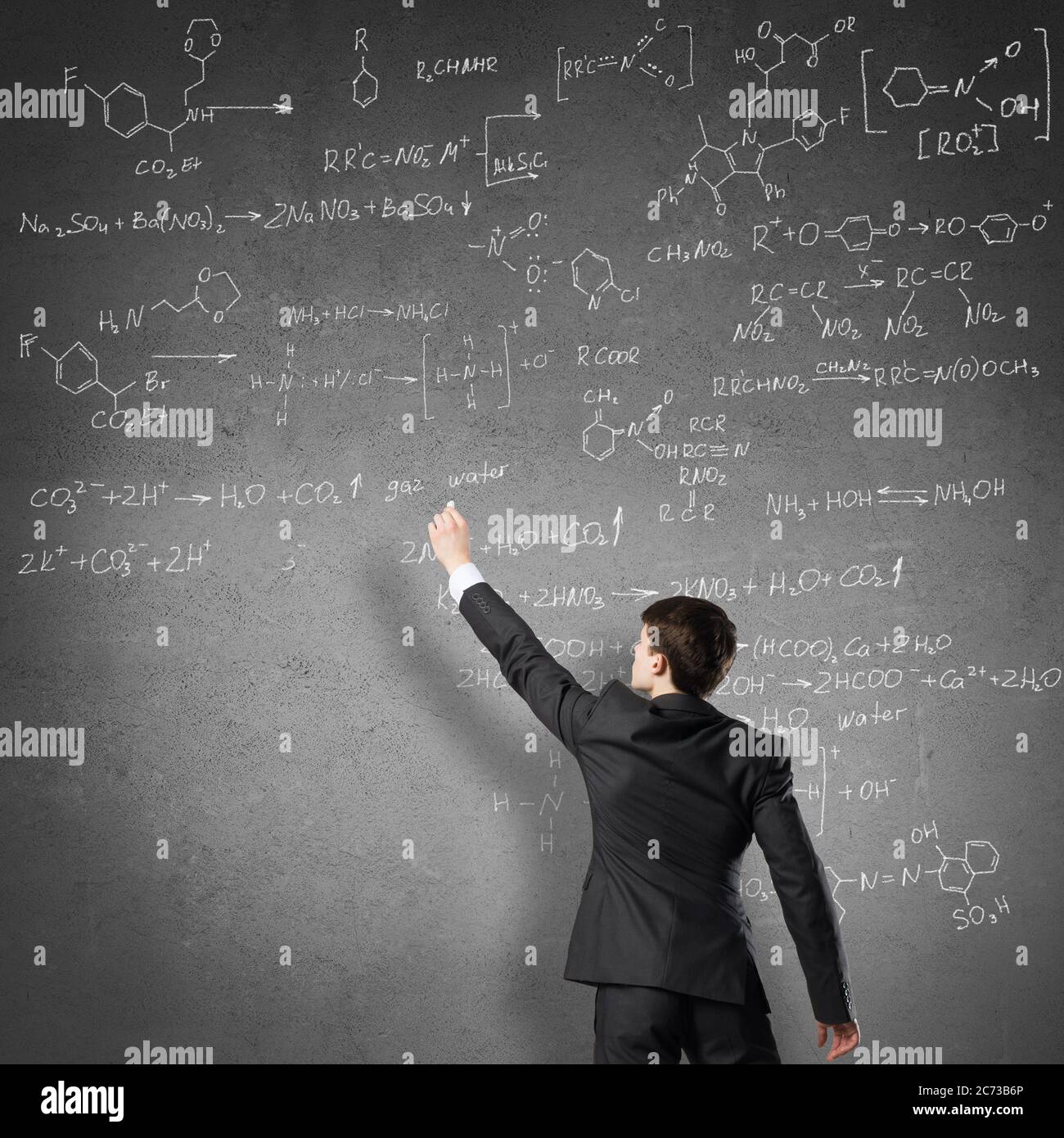 Scientist writing formulas on chalkboard Stock Photo - Alamy