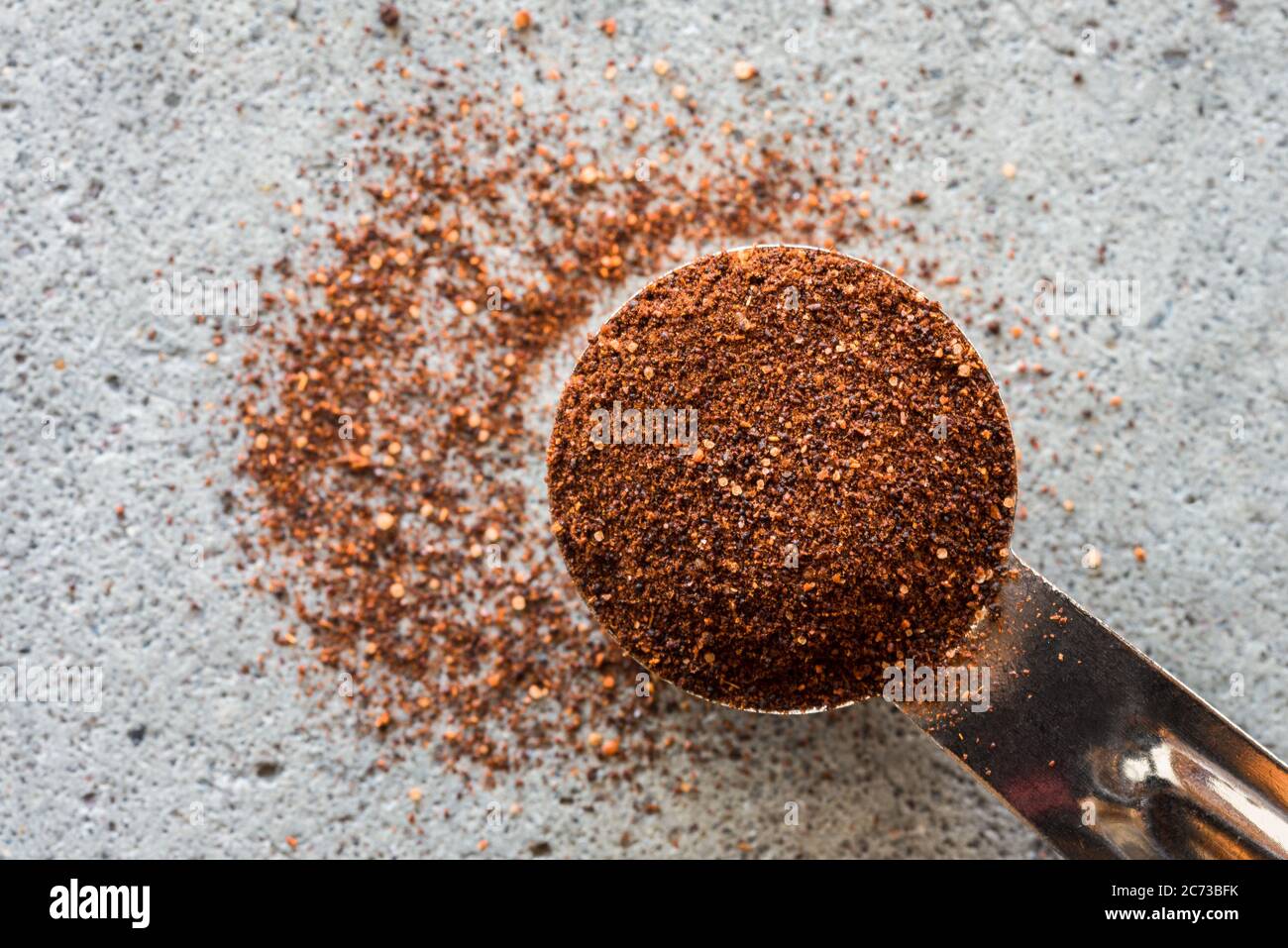 Chili Powder Spilled from a teaspoon Stock Photo - Alamy