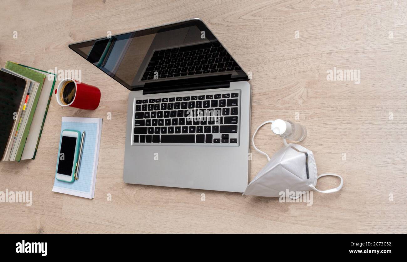 Work station with hygienic safety measures. You can see a laptop, a ...