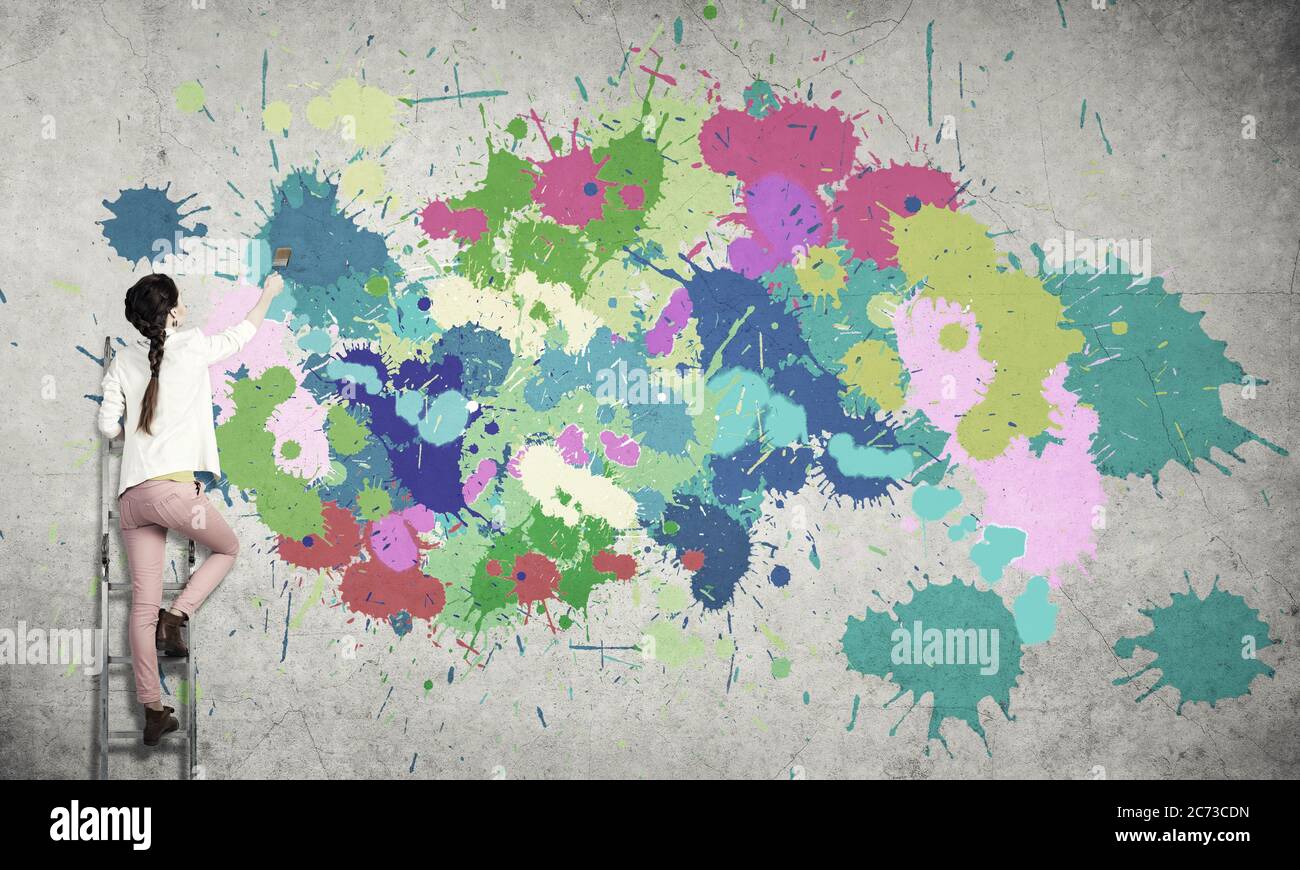 Girl paint wall in colors Stock Photo - Alamy
