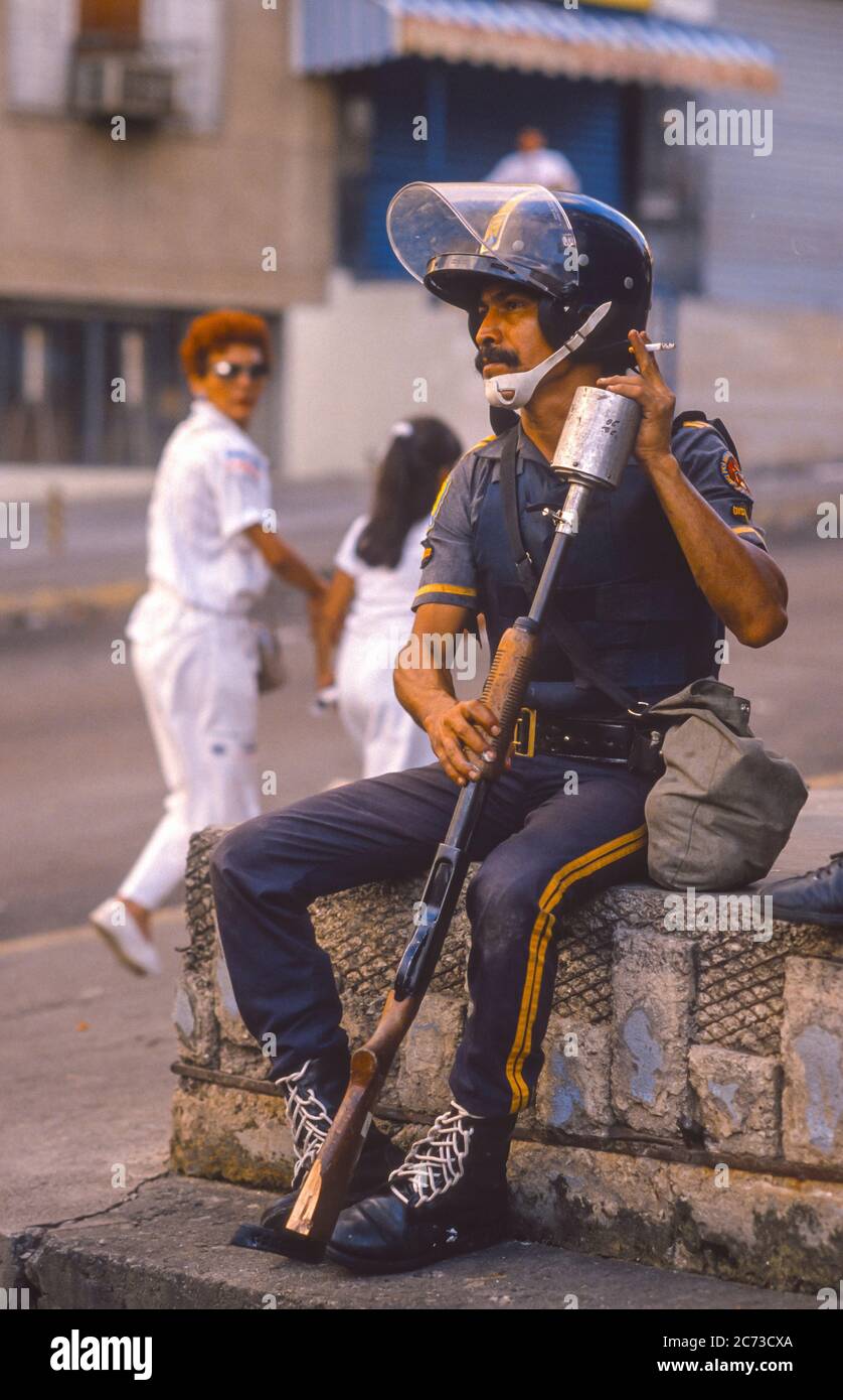 CARACAS, VENEZUELA, MARCH1989 - Police officer with tear gas rifle ...