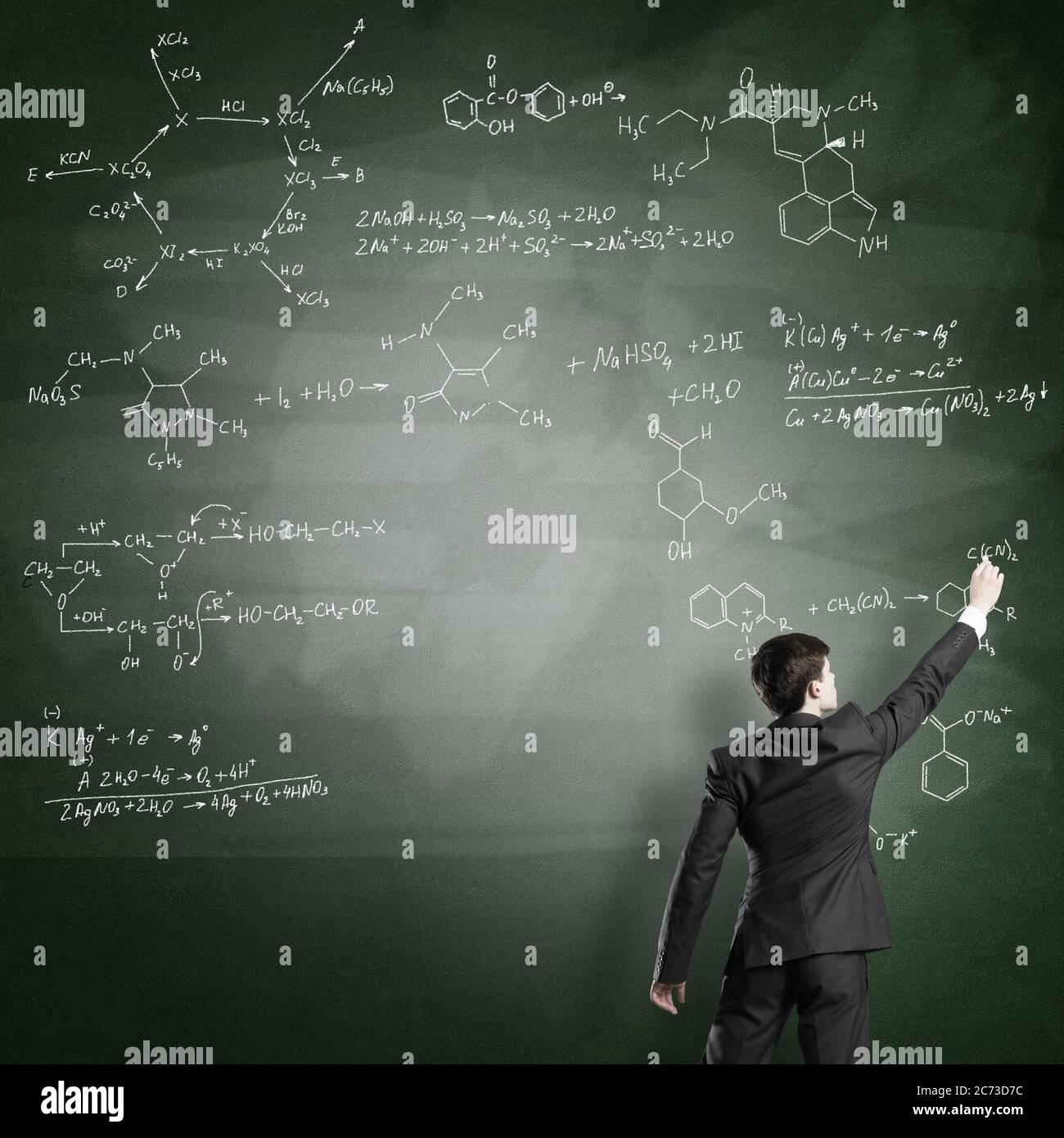 Scientist writing formulas on chalkboard Stock Photo - Alamy