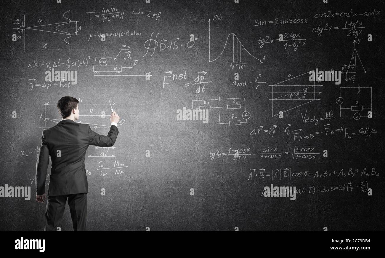 Man writing on blackboard Stock Photo - Alamy