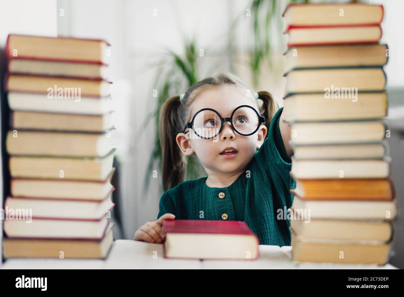 Little preschool cute girl genius reads a lot of of books. Kids ...