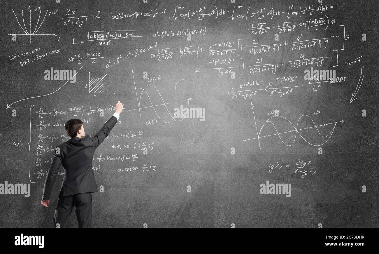 Man writing on blackboard Stock Photo - Alamy