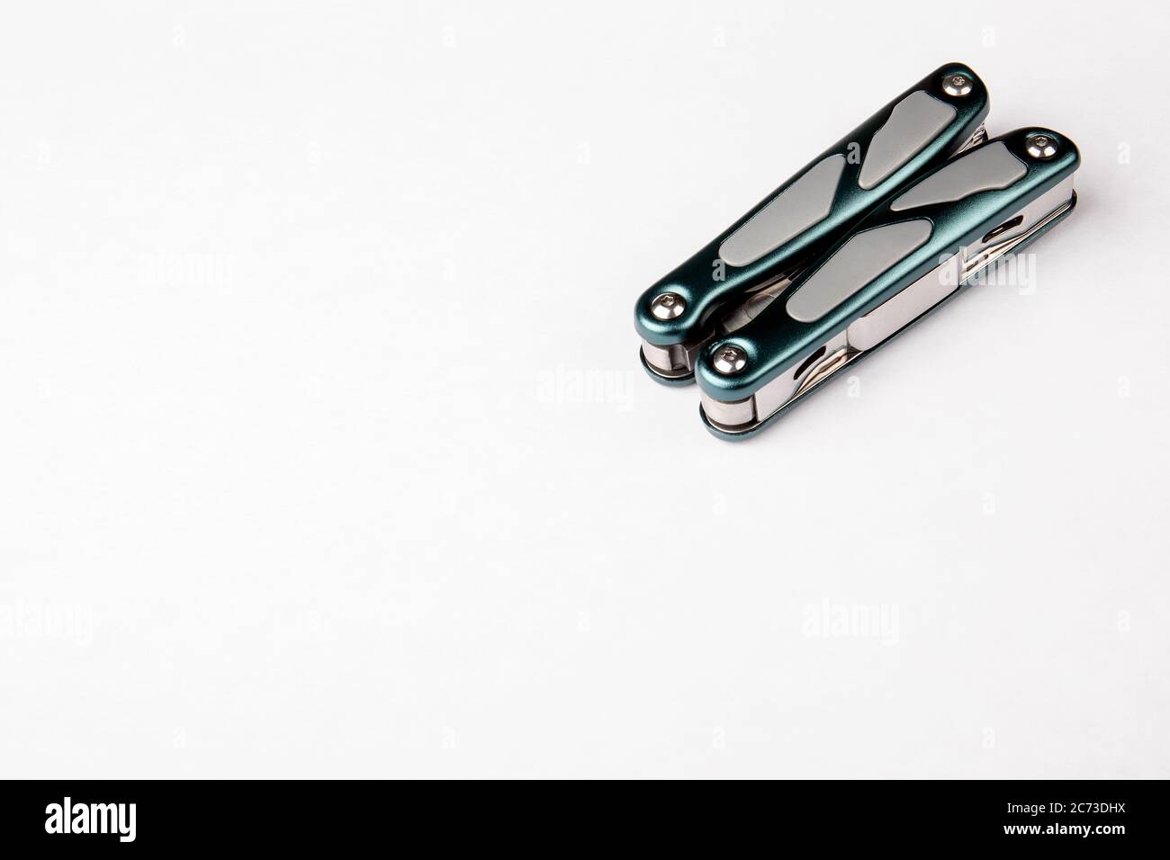 Compact multitool on white background. Top view. Tools for cutting ...