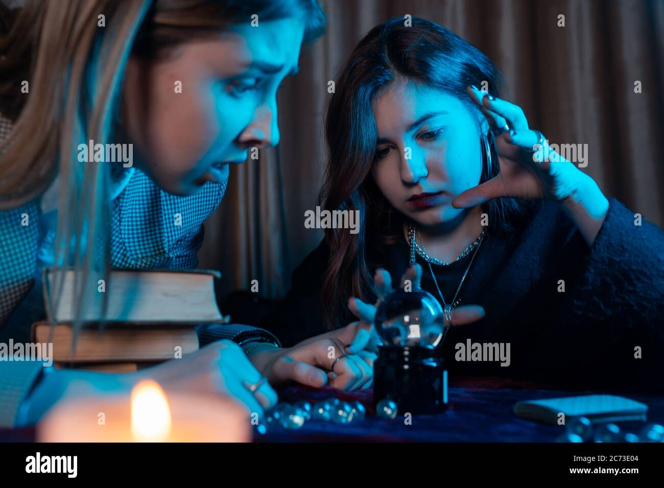 Woman and woman fortune teller with crystal ball Stock Photo - Alamy