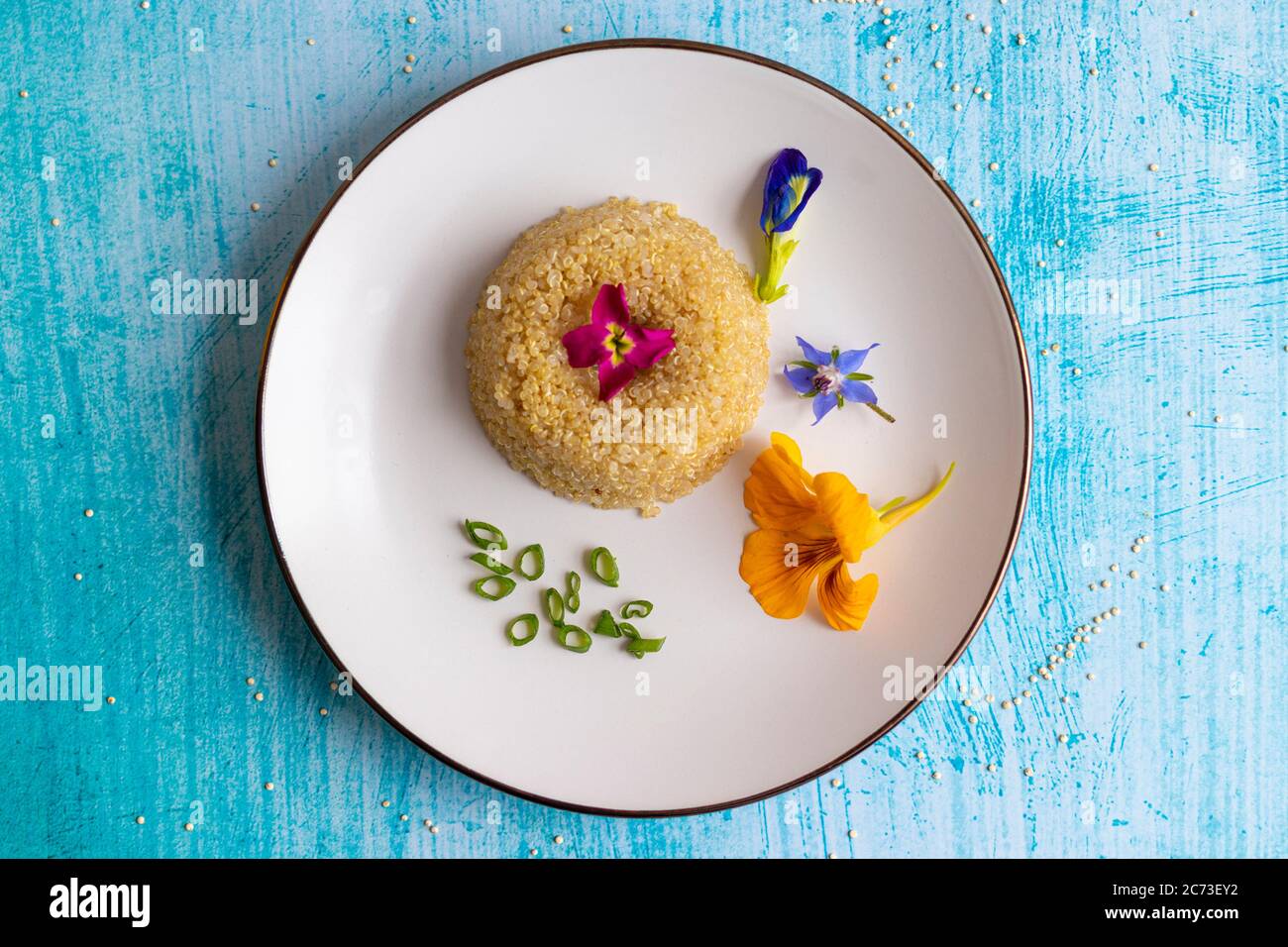 Quinoa plate presentation decorated with edible flowers Stock Photo - Alamy