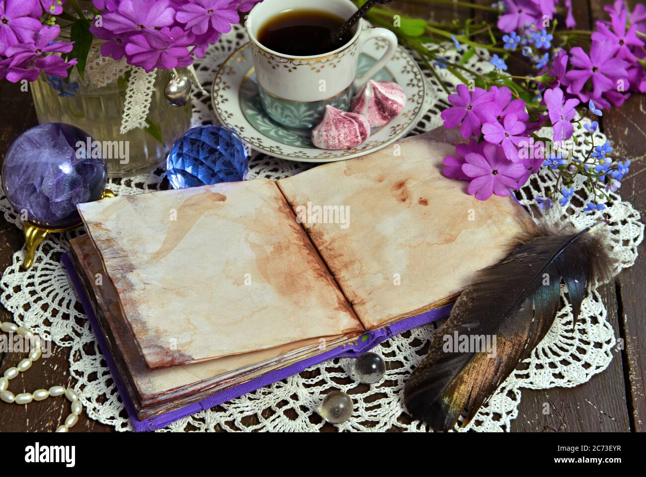 Cozy still life with open diary with blank pages, crystal, primrose ...