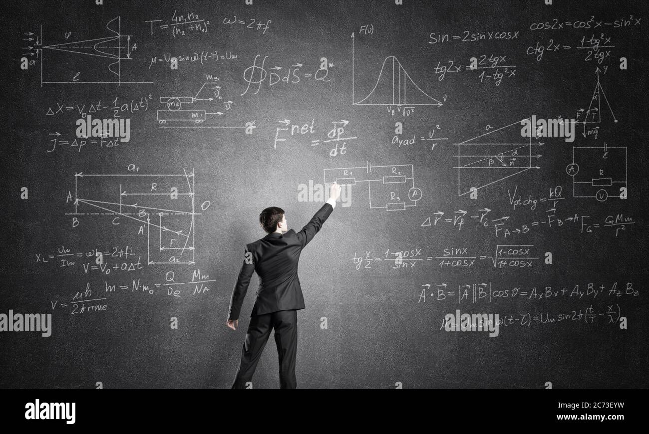 Man writing on blackboard Stock Photo - Alamy