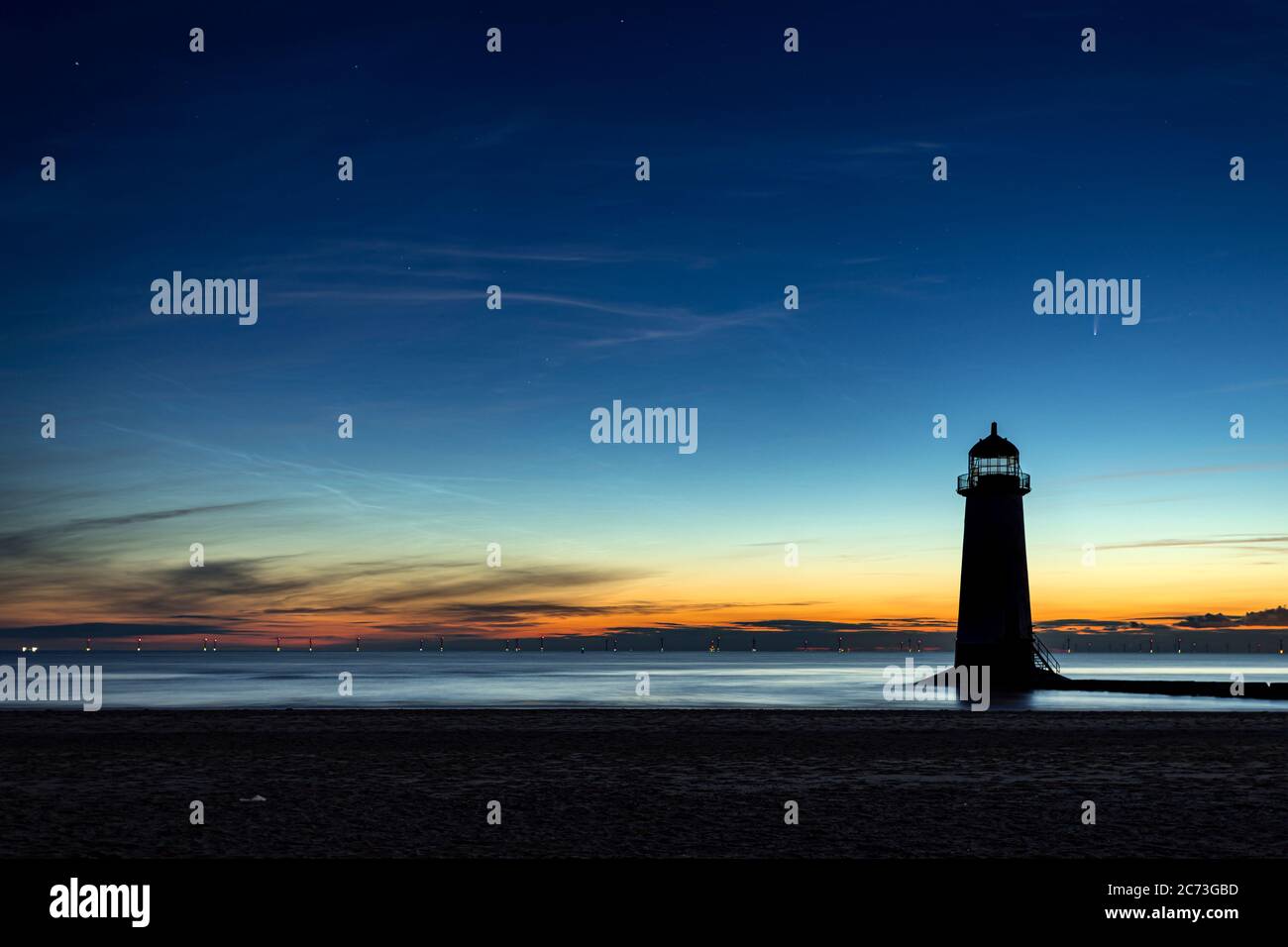 Comet Neowise over Point of Ayr lighthouse at dawn, North Wales Stock ...