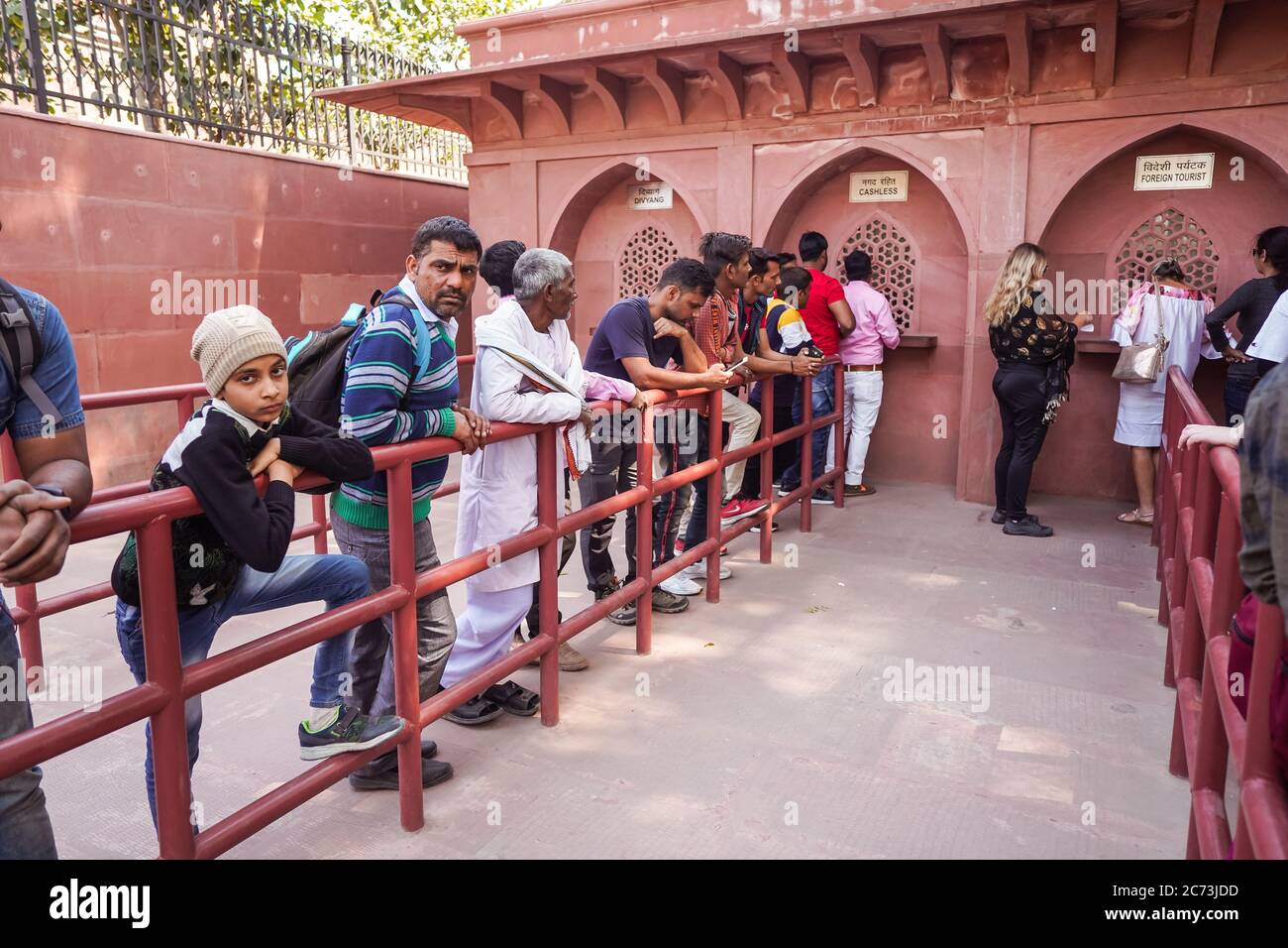 New Delhi / India - February 19, 2020: queue of Indian men looking at ...