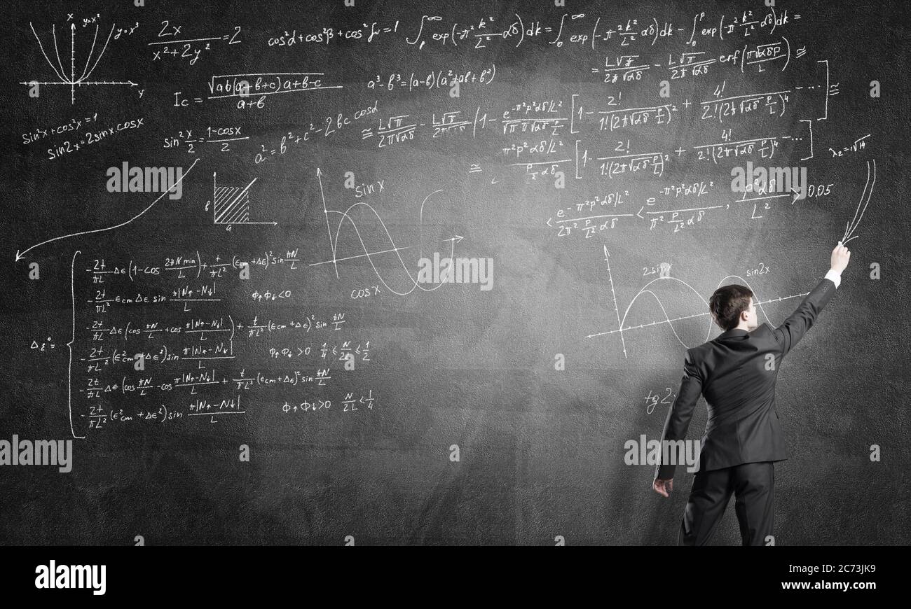 Man writing on blackboard Stock Photo - Alamy
