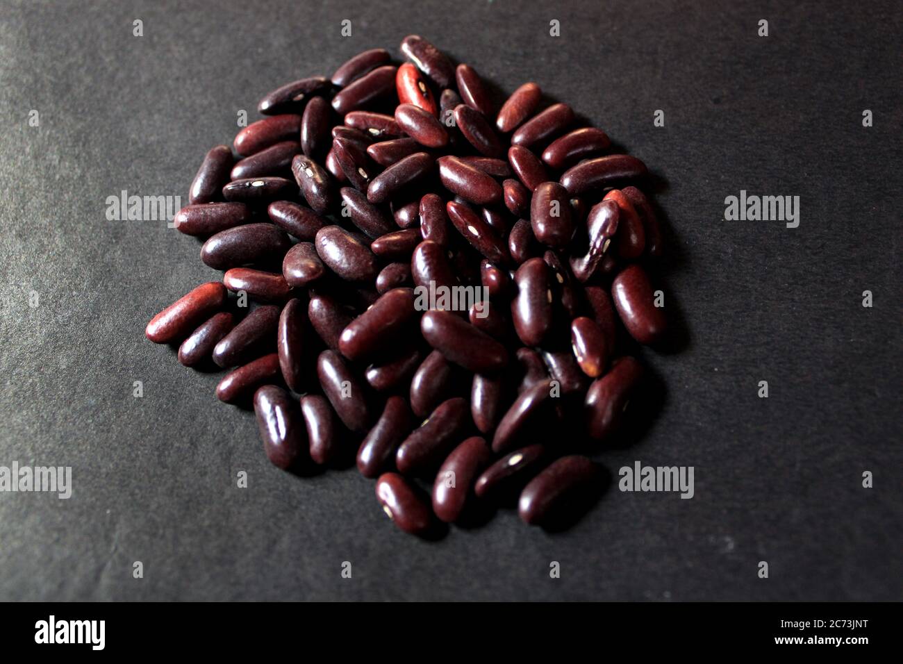 Red kidney beans isolated on black background. Closeup of Multiple red ...
