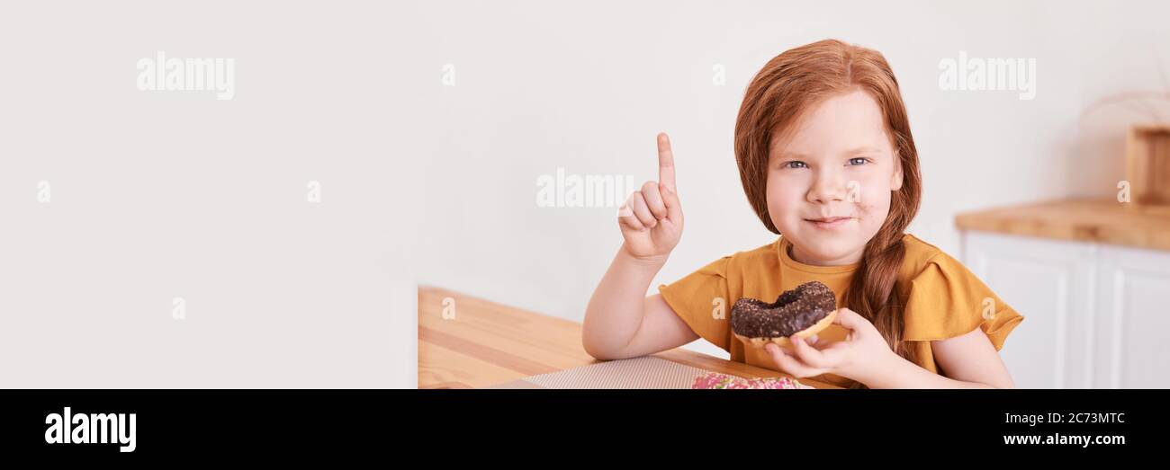 Little girl eating round doughnut. Sweet desert. Unhealthy food ...