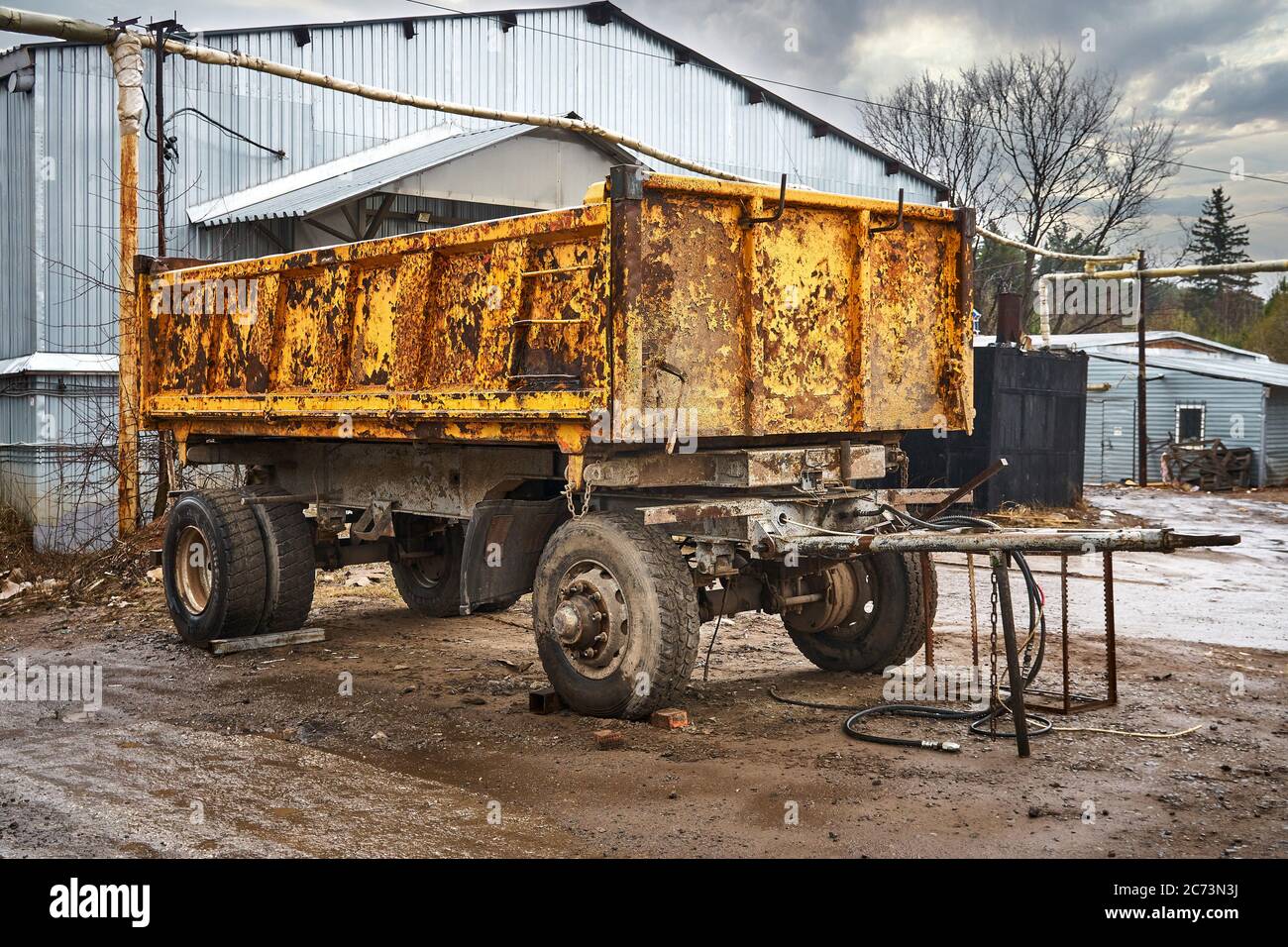 Old yellow heavy truck semi-trailer at the warehouse of building ...