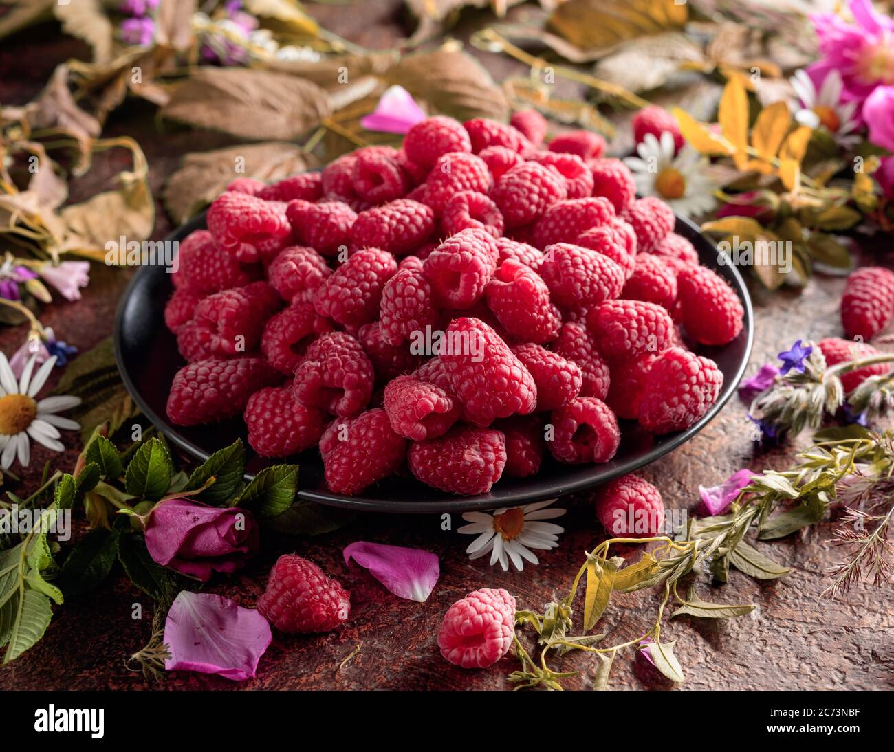 Fresh juicy raspberries on a black plate. Still life with, raspberries ...