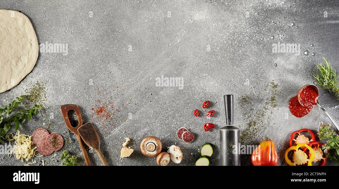 Panorama banner with pizza ingredient border with a raw pastry base ...