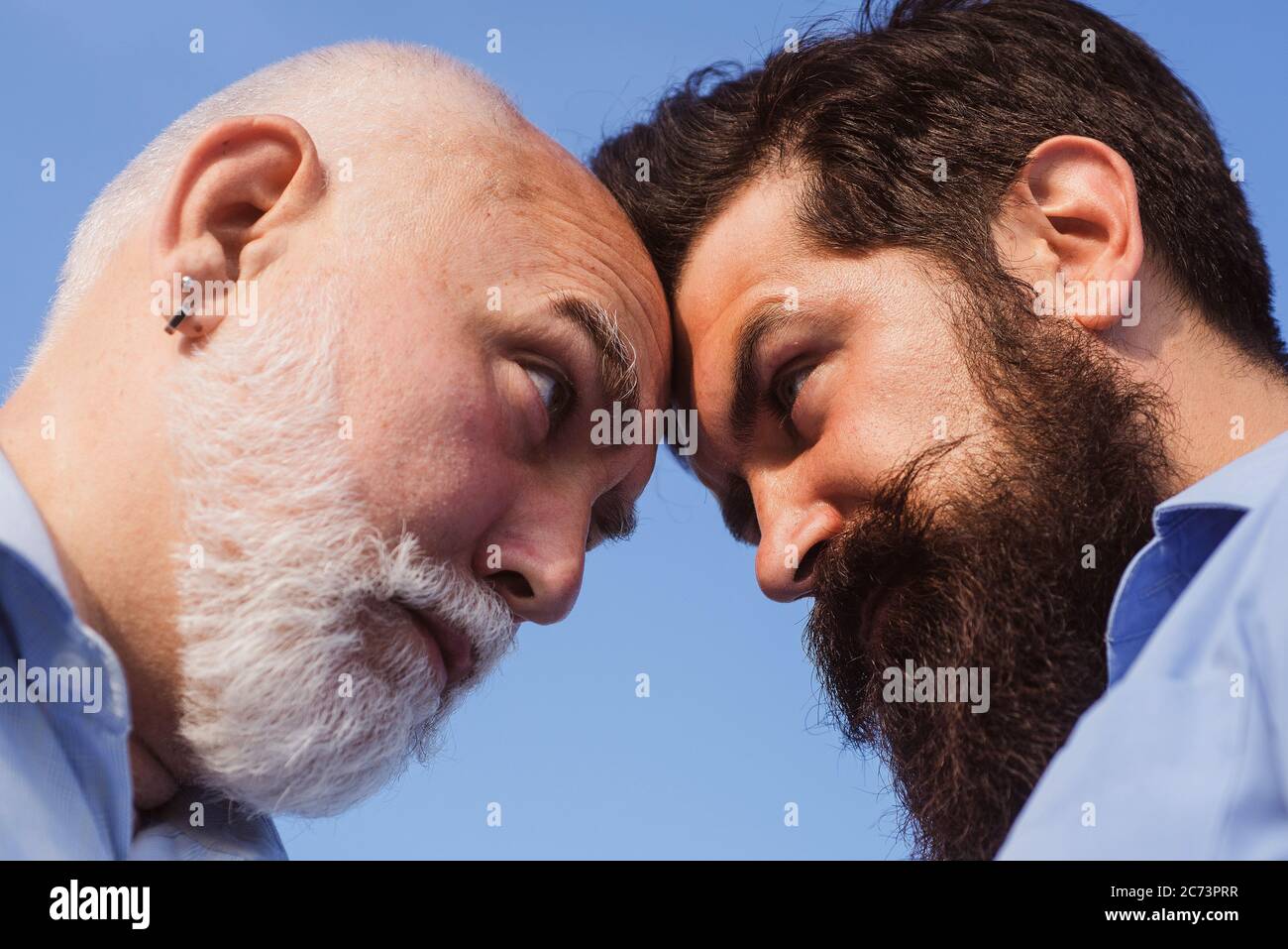 Man looking at each other - close up portrait. Man in different ages ...