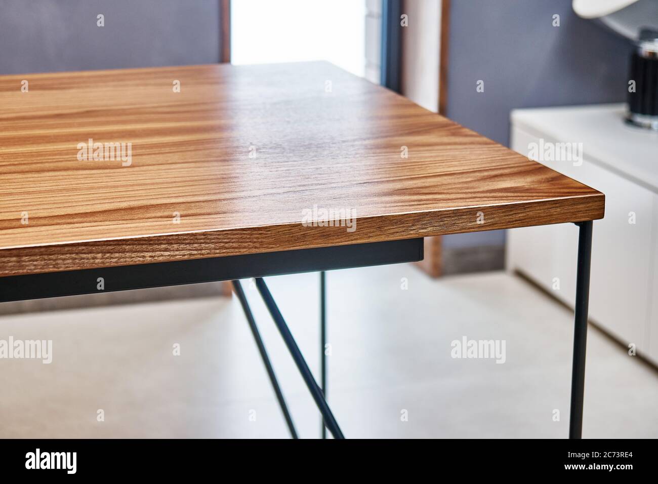 Wooden office desk . Walnut veneer desk with metal base. Close-up Stock ...