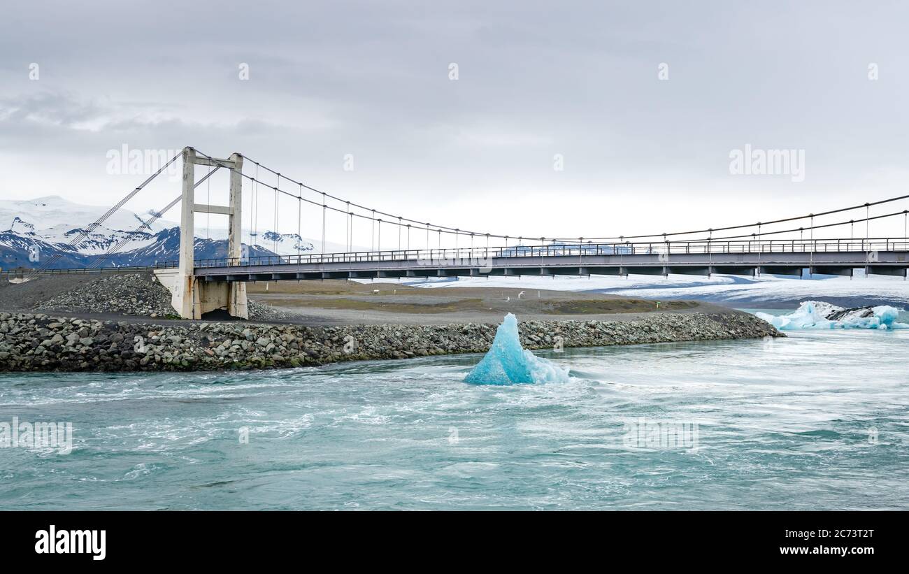 A big melting ice block floating towards the ocean in Jokulsarlon ...