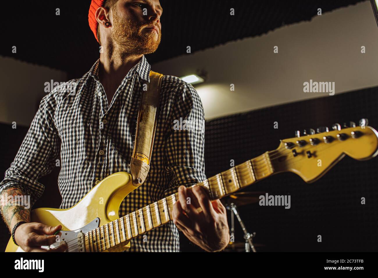 rock and roll. professional musician play electric guitar in studio ...