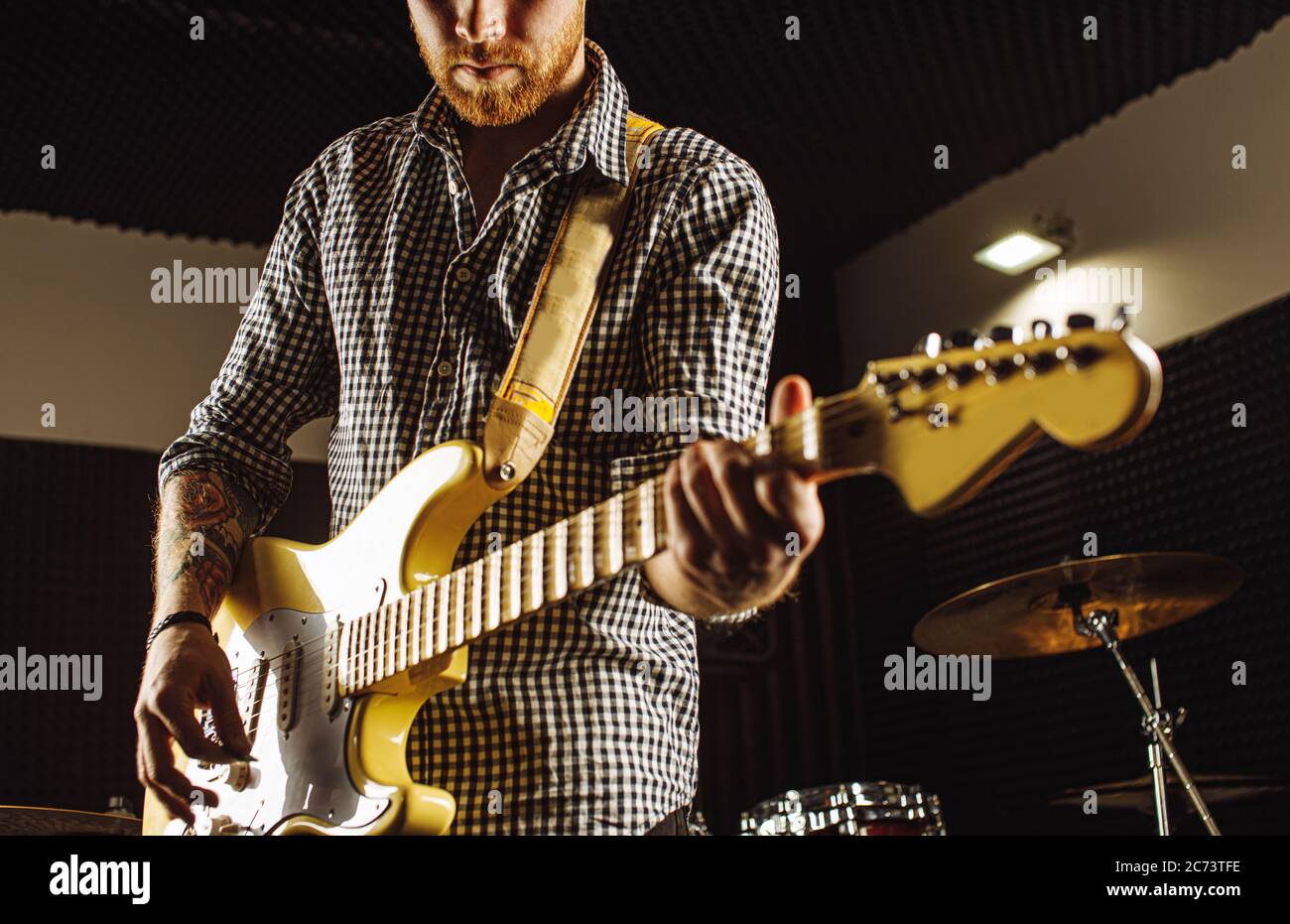 cropped caucasian man perform music with the use of electric guitar ...
