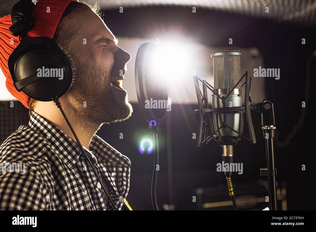 handsome caucasian guy in recording studio. young man professional ...