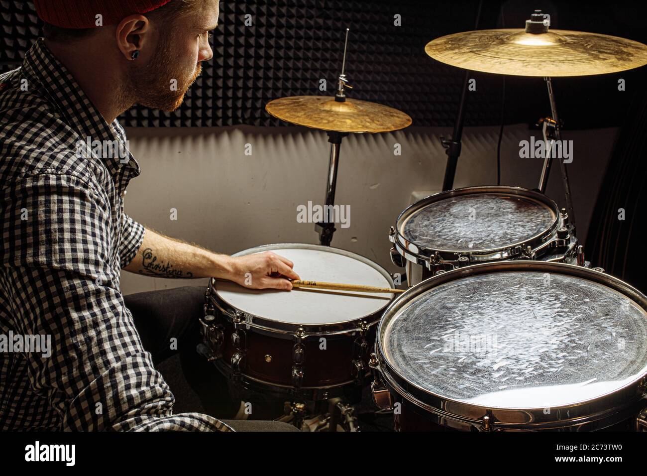 young caucasian drummer rehearsing on drums before rock concert ...